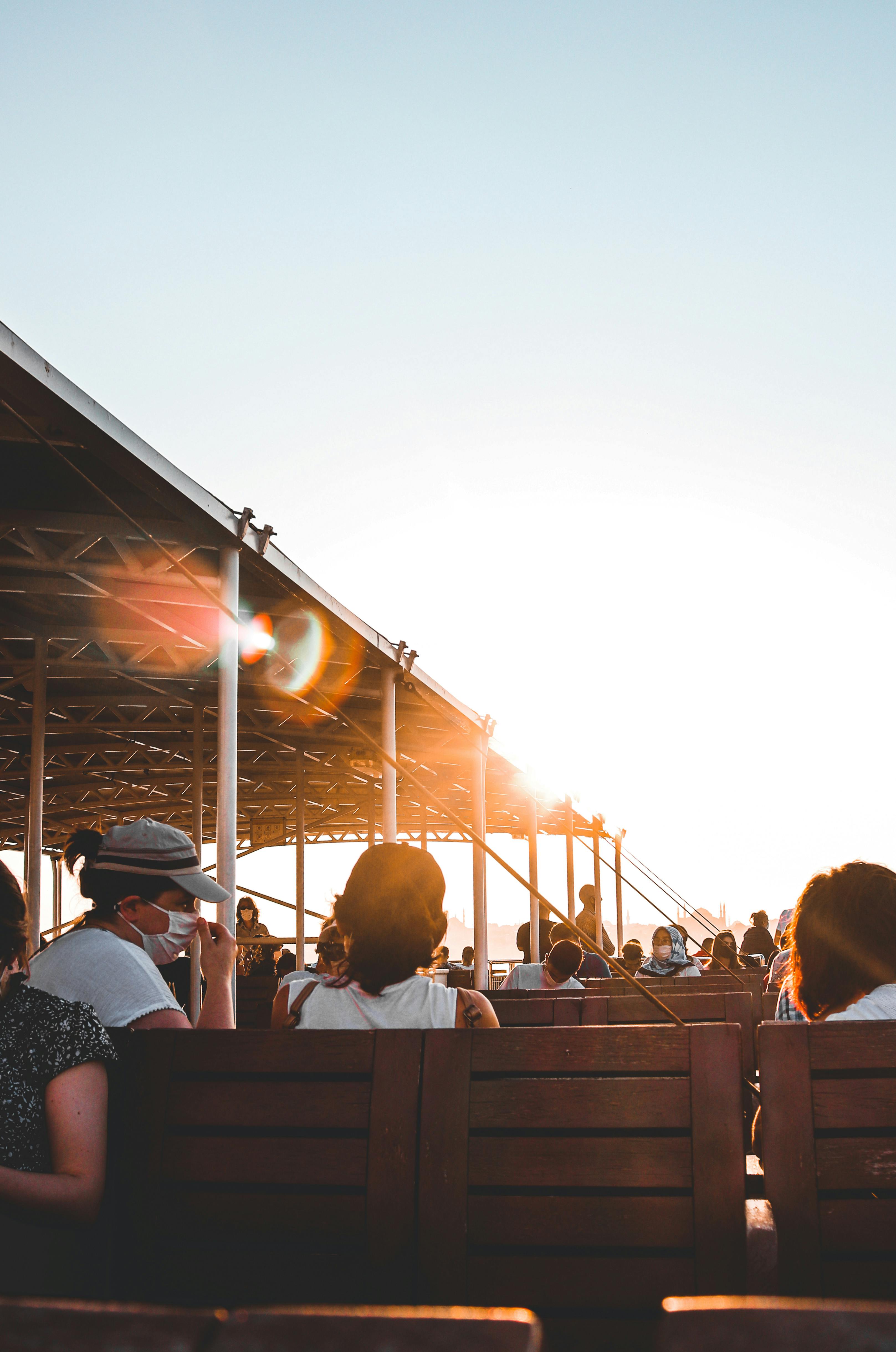 Sunset Gathering on Rooftop Terrace with Lens Flare · Free Stock Photo