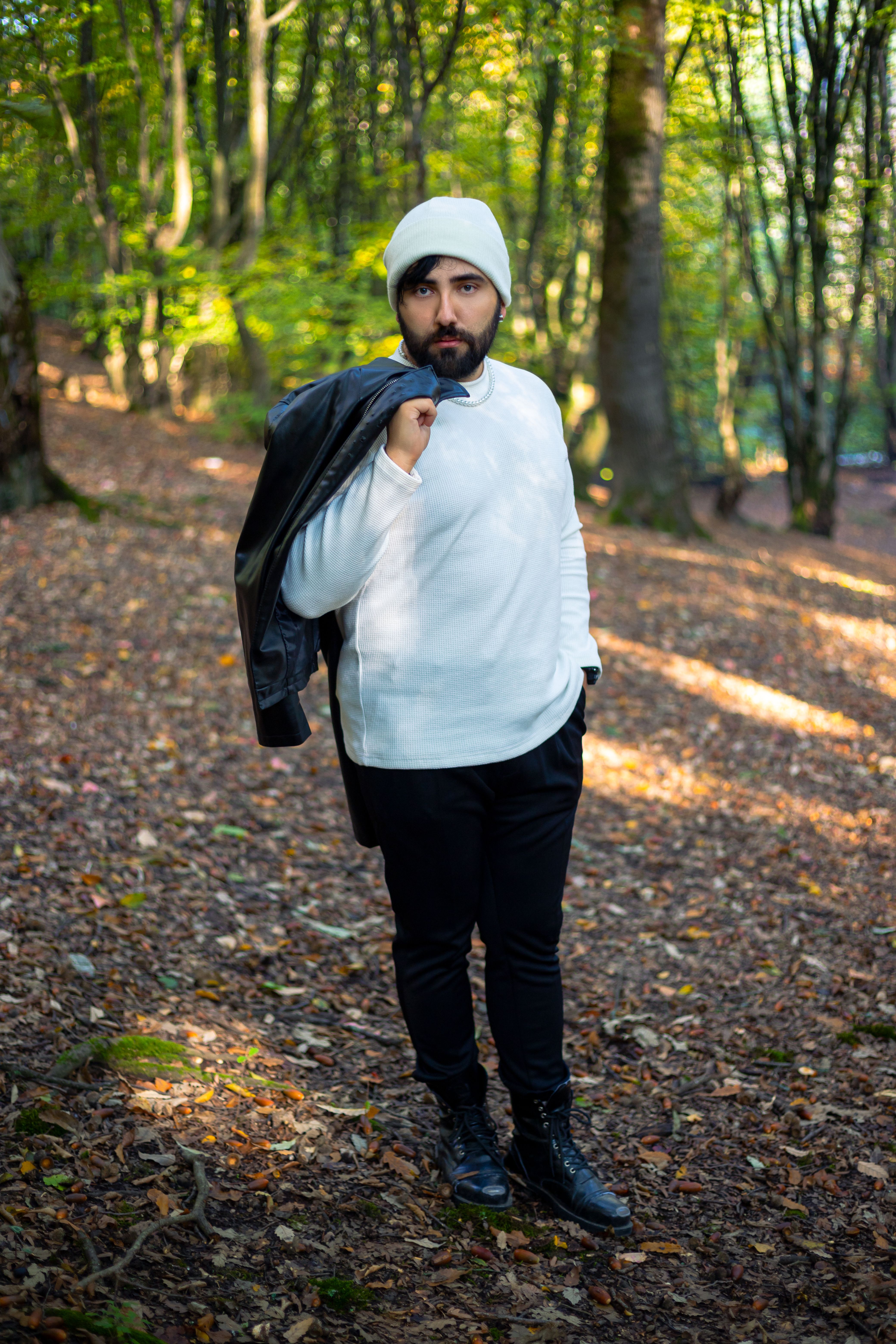 Man in White Sweater Walking Through Autumn Forest · Free Stock Photo