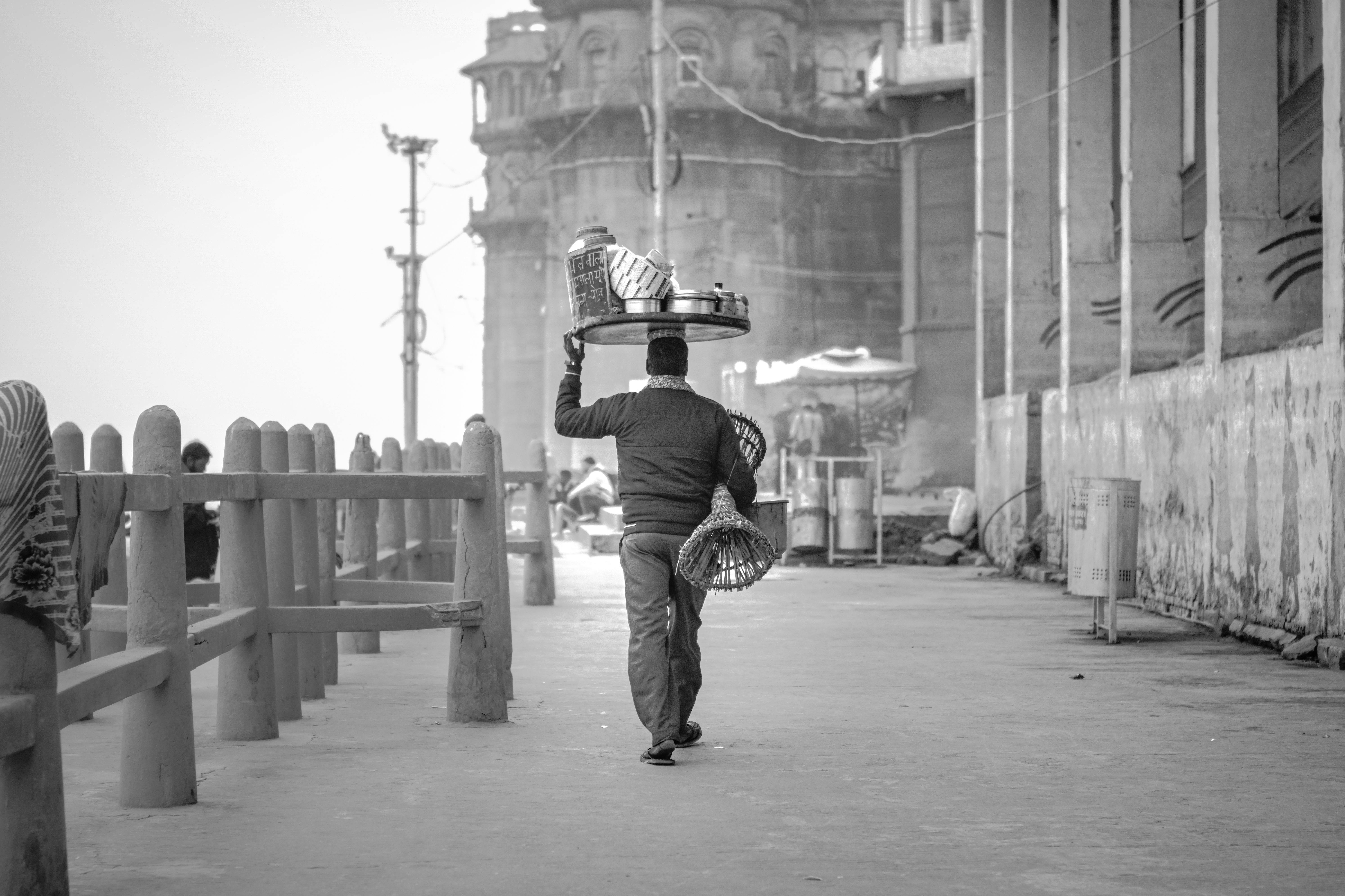 Street Vendor Walking Along Ghats in Varanasi · Free Stock Photo