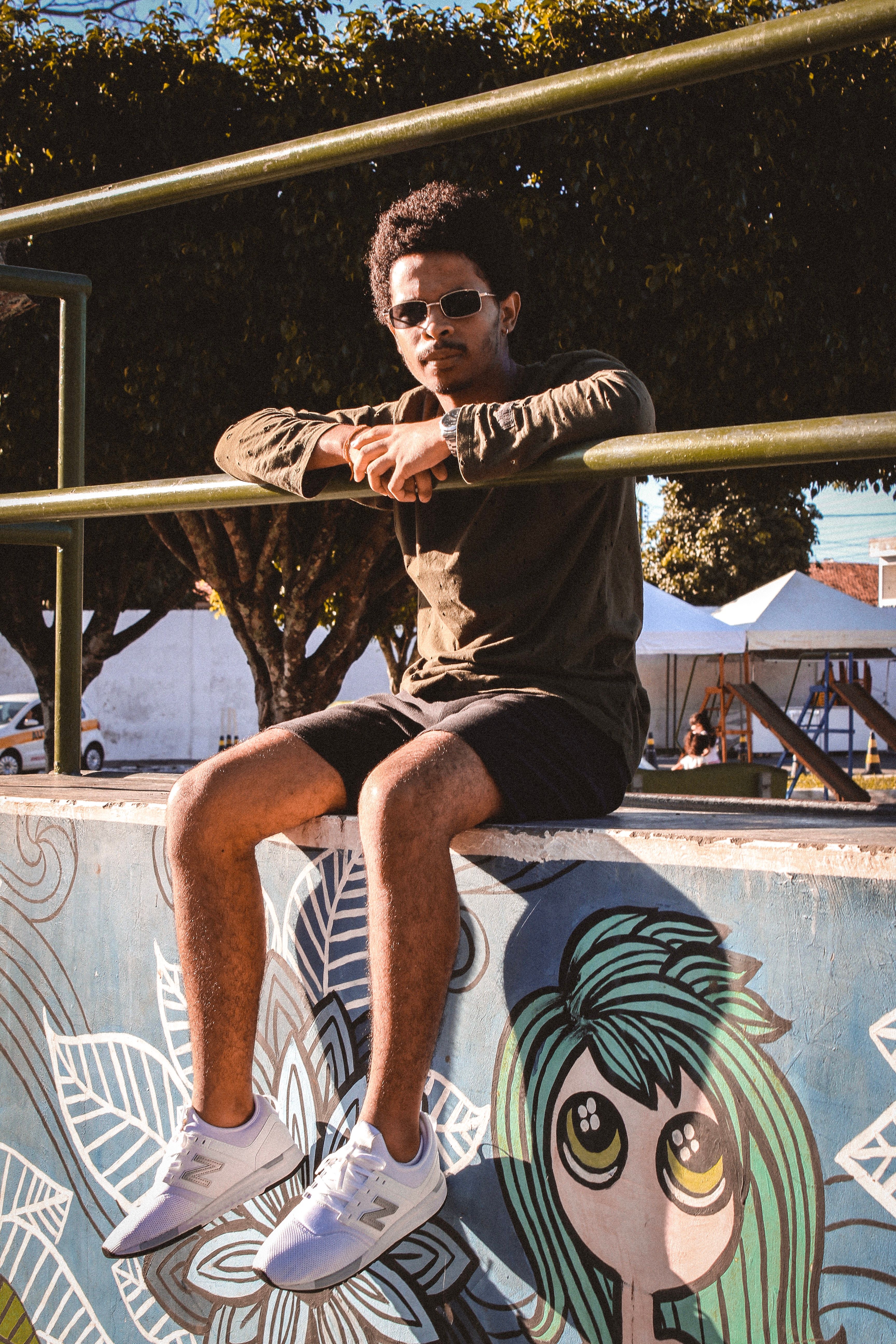 Man Lying Forward on Stool Near Wall · Free Stock Photo