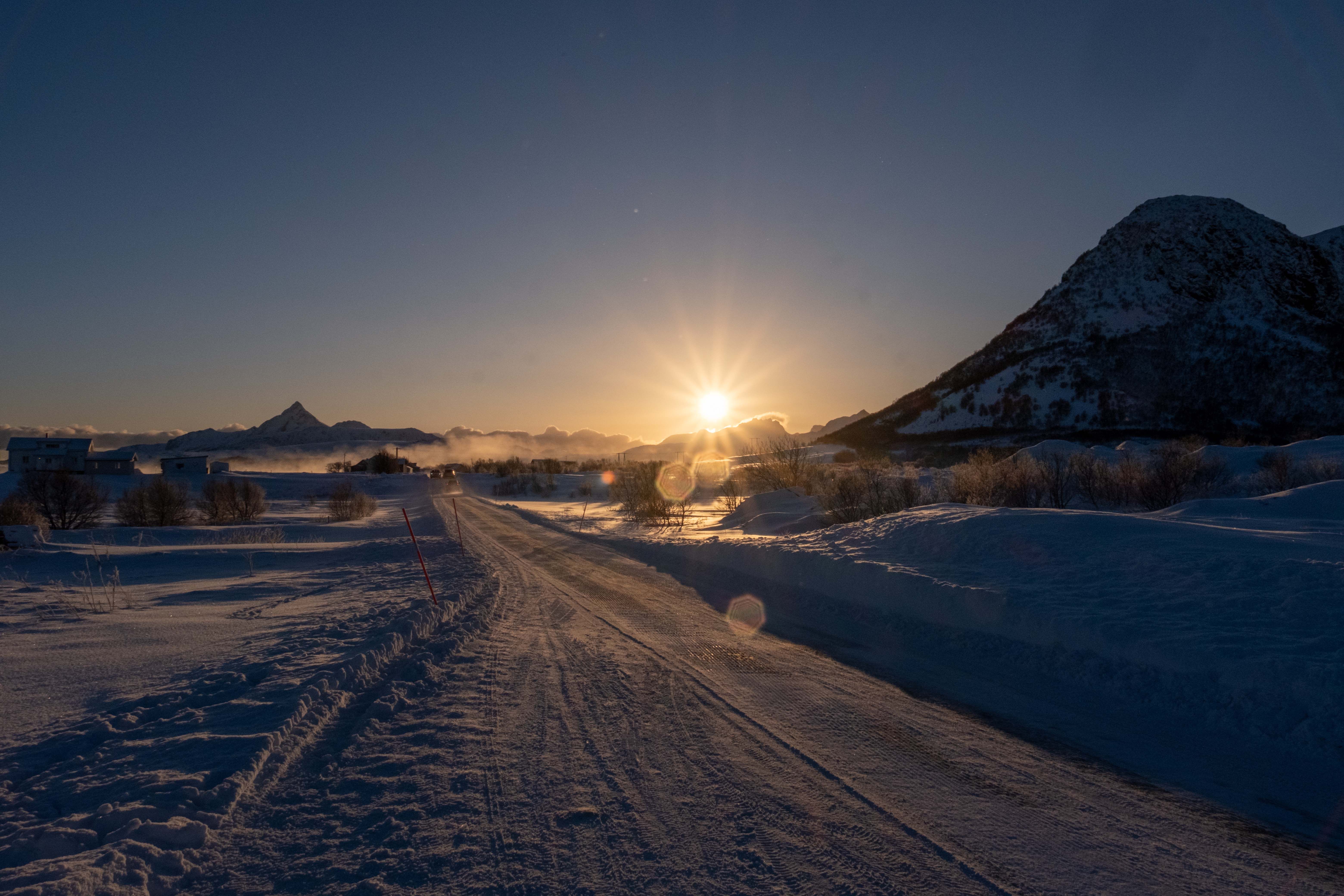 Serene Winter Sunset on Snowy Mountain Road · Free Stock Photo