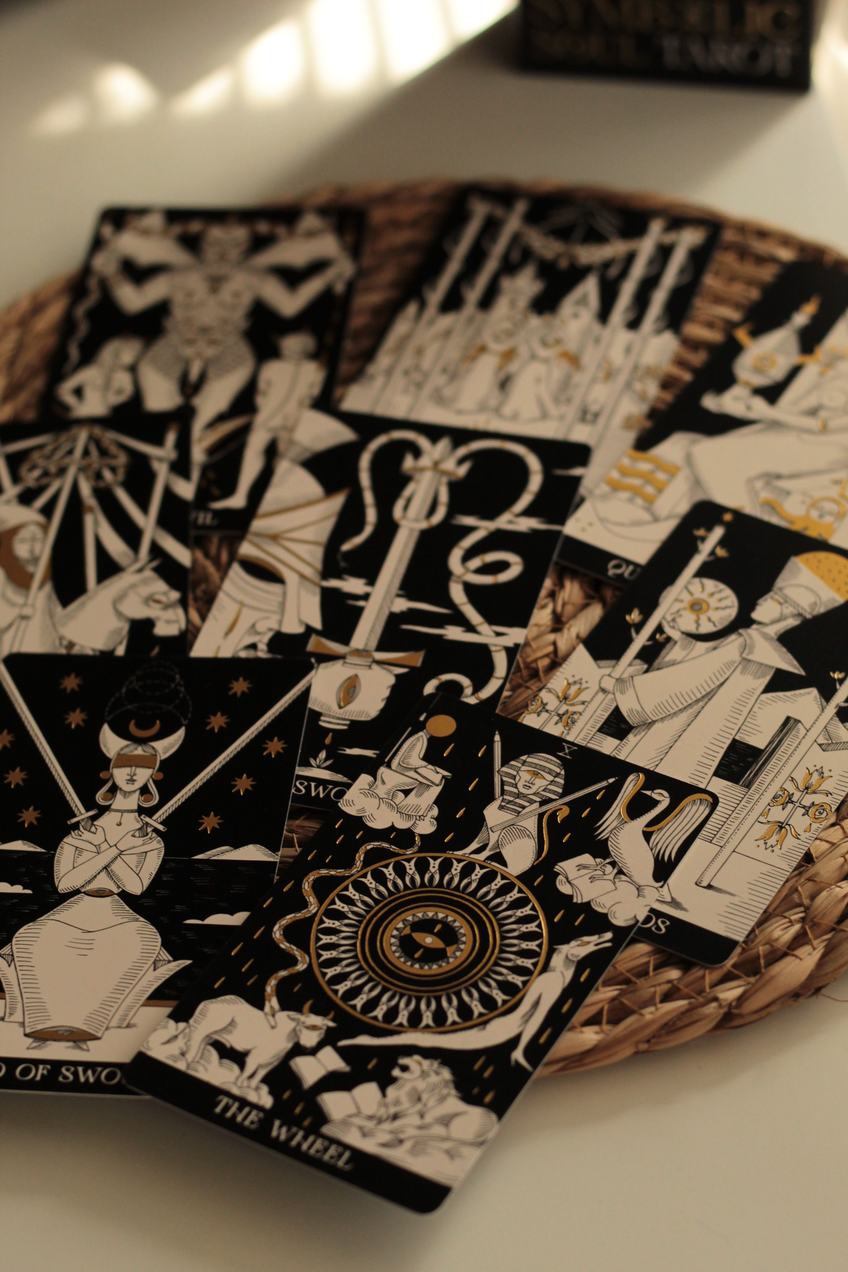 Artistic Tarot Cards Spread on a Wicker Mat · Free Stock Photo