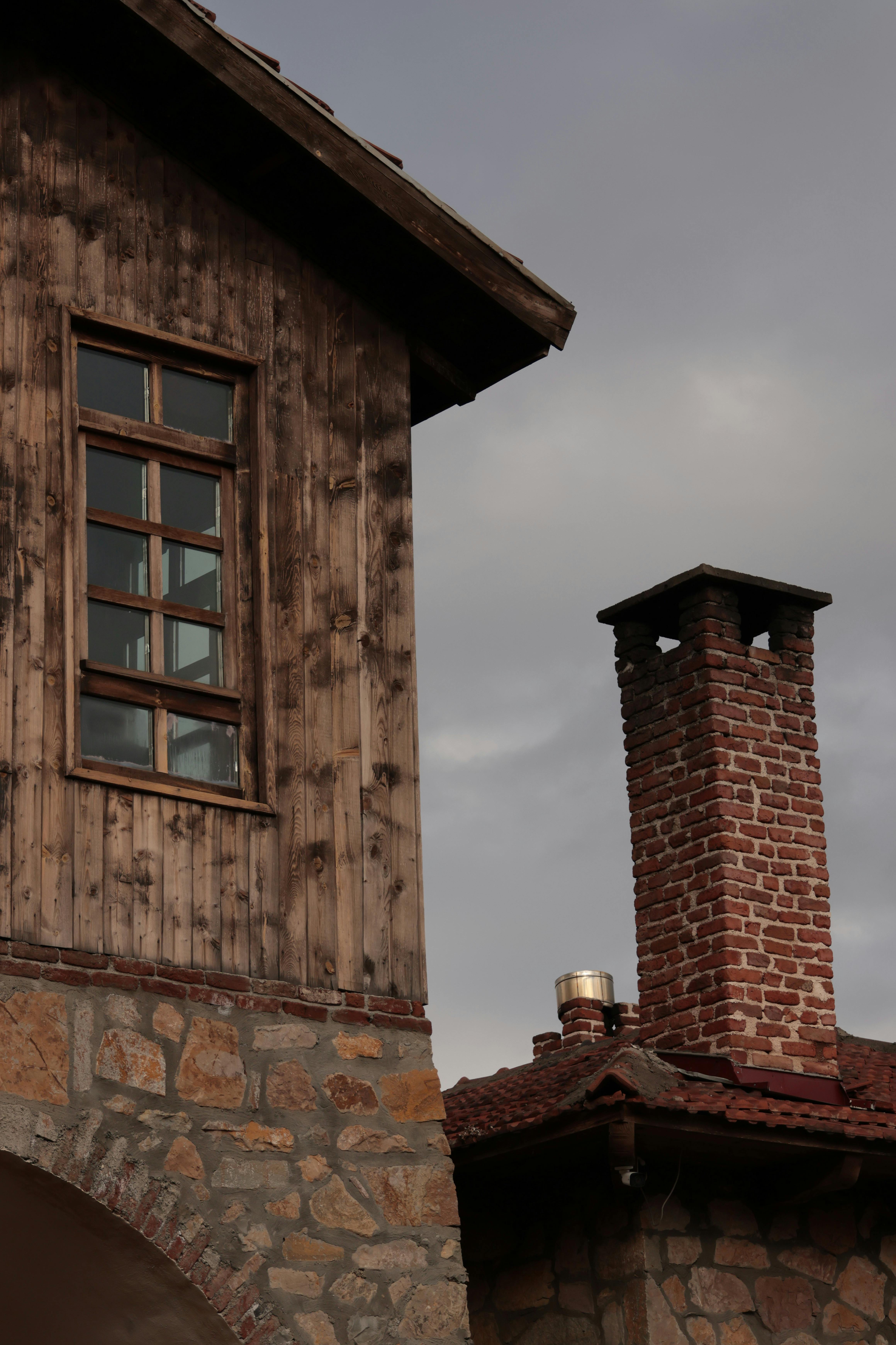 Rustic Wooden House with Brick Chimney · Free Stock Photo