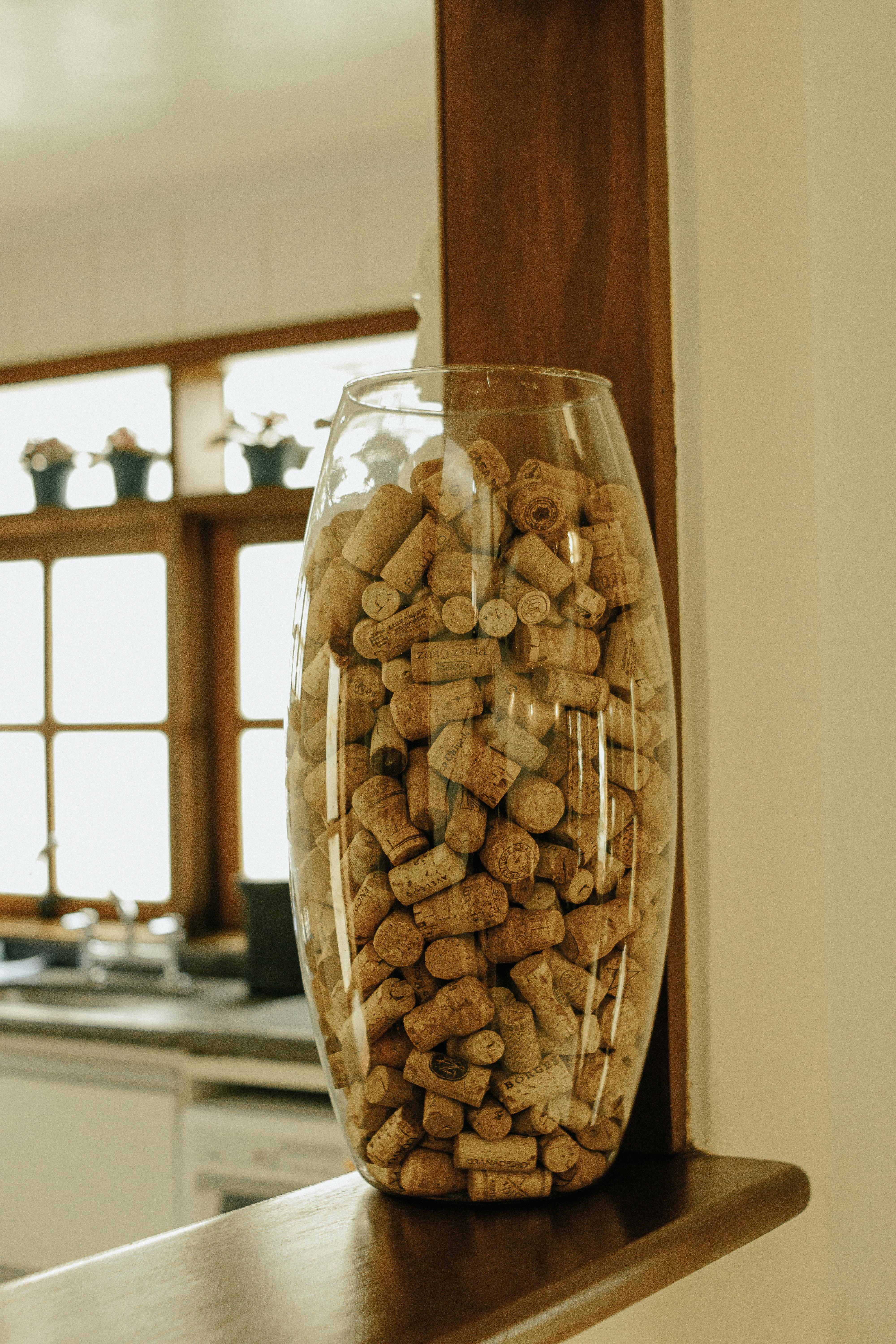 Glass Vase Filled with Wine Corks in Rustic Kitchen · Free Stock Photo