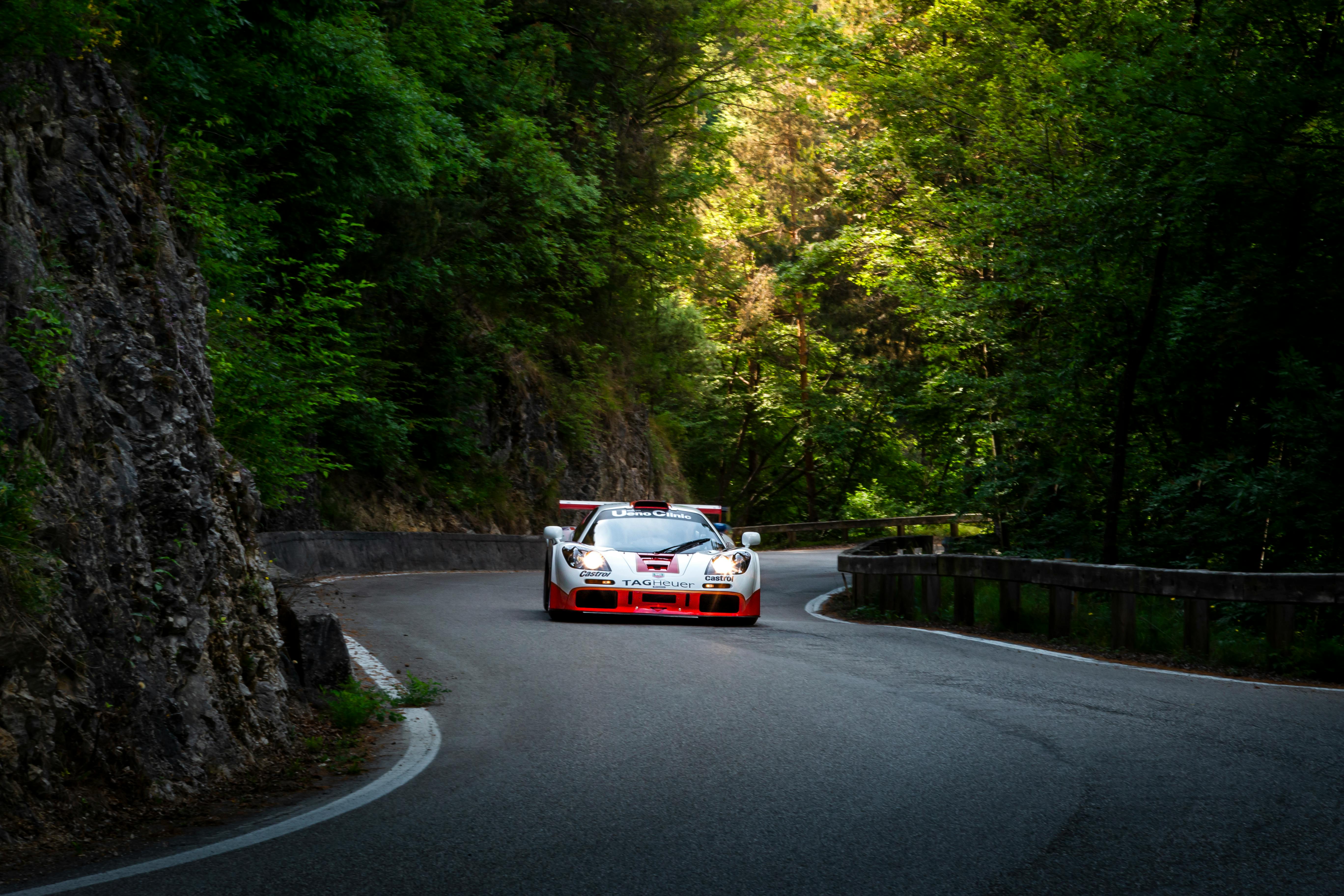 Exotic Supercar Navigating Scenic Mountain Road · Free Stock Photo