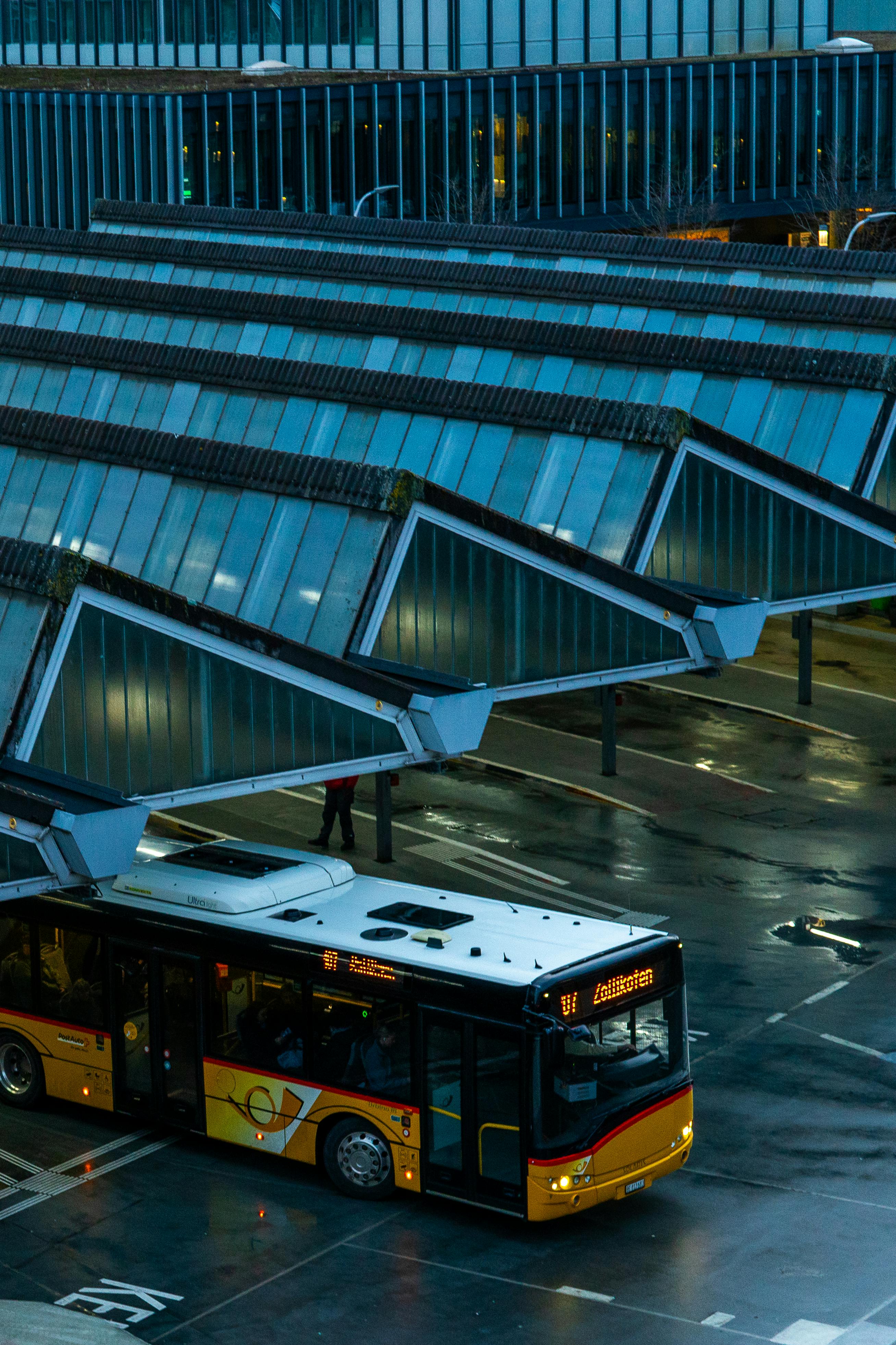Urban Bus Station at Dusk with Modern Architecture · Free Stock Photo
