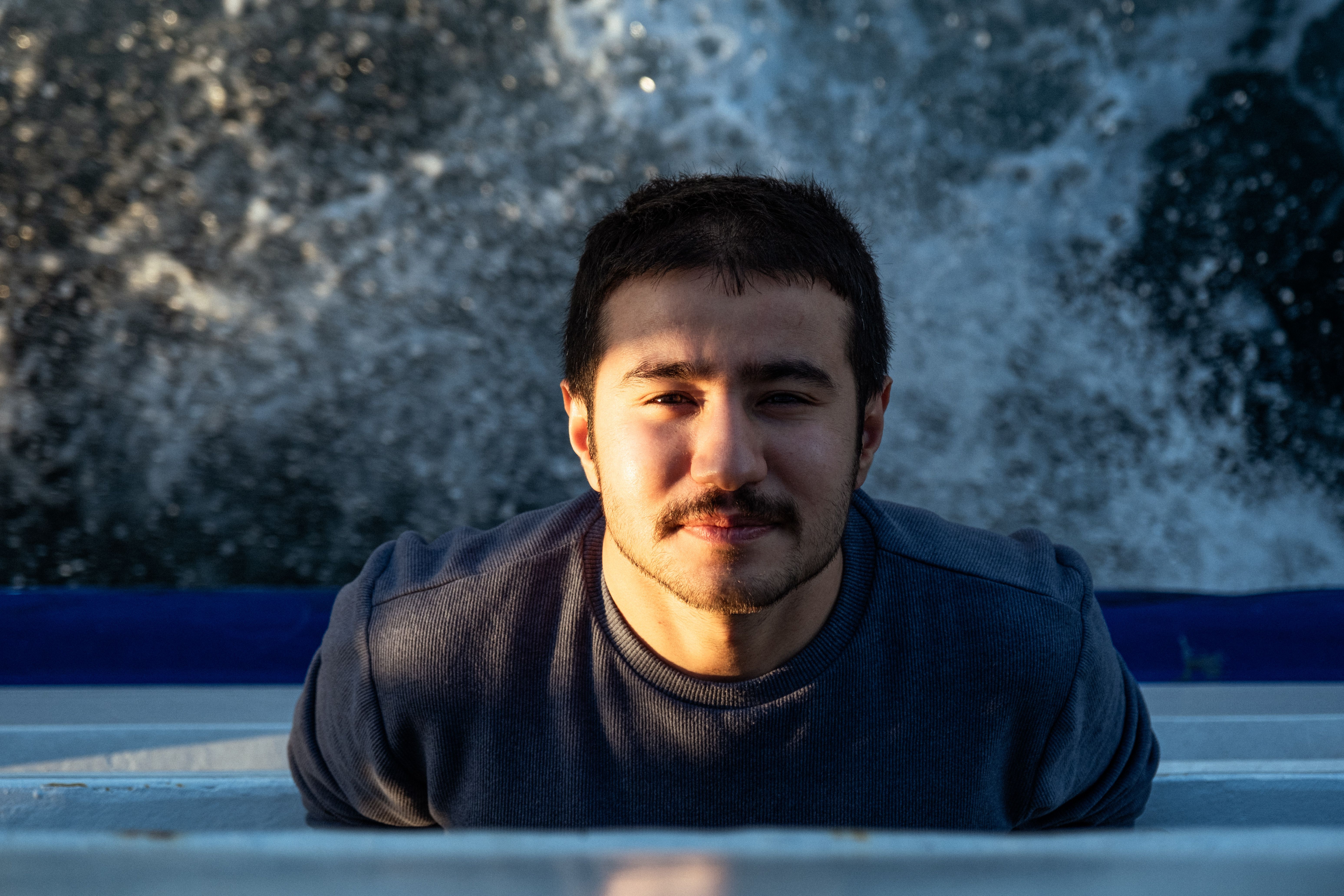 Young Man Enjoying a Sunny Day on the Water · Free Stock Photo