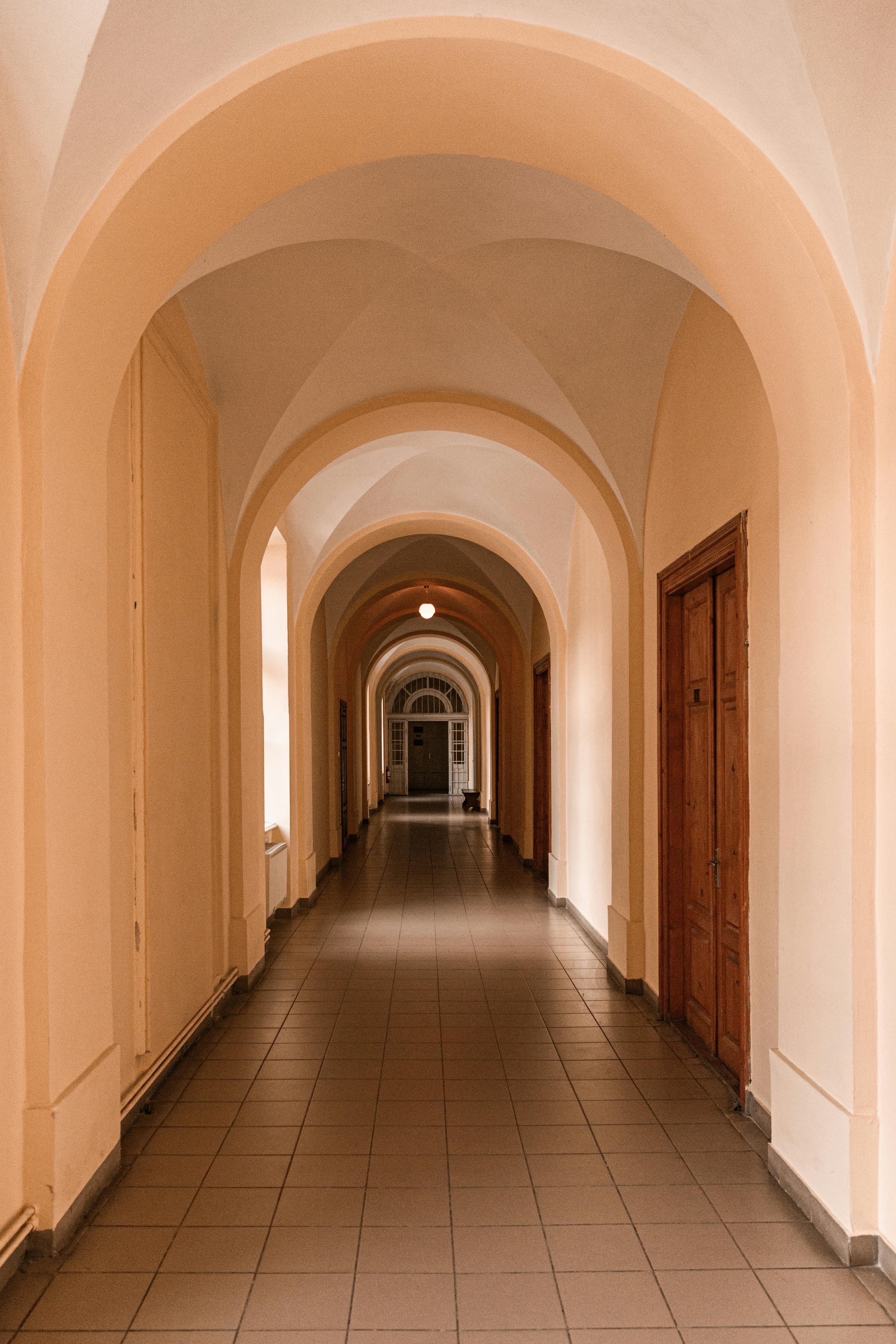 Elegant Archway Corridor in Historic Building · Free Stock Photo