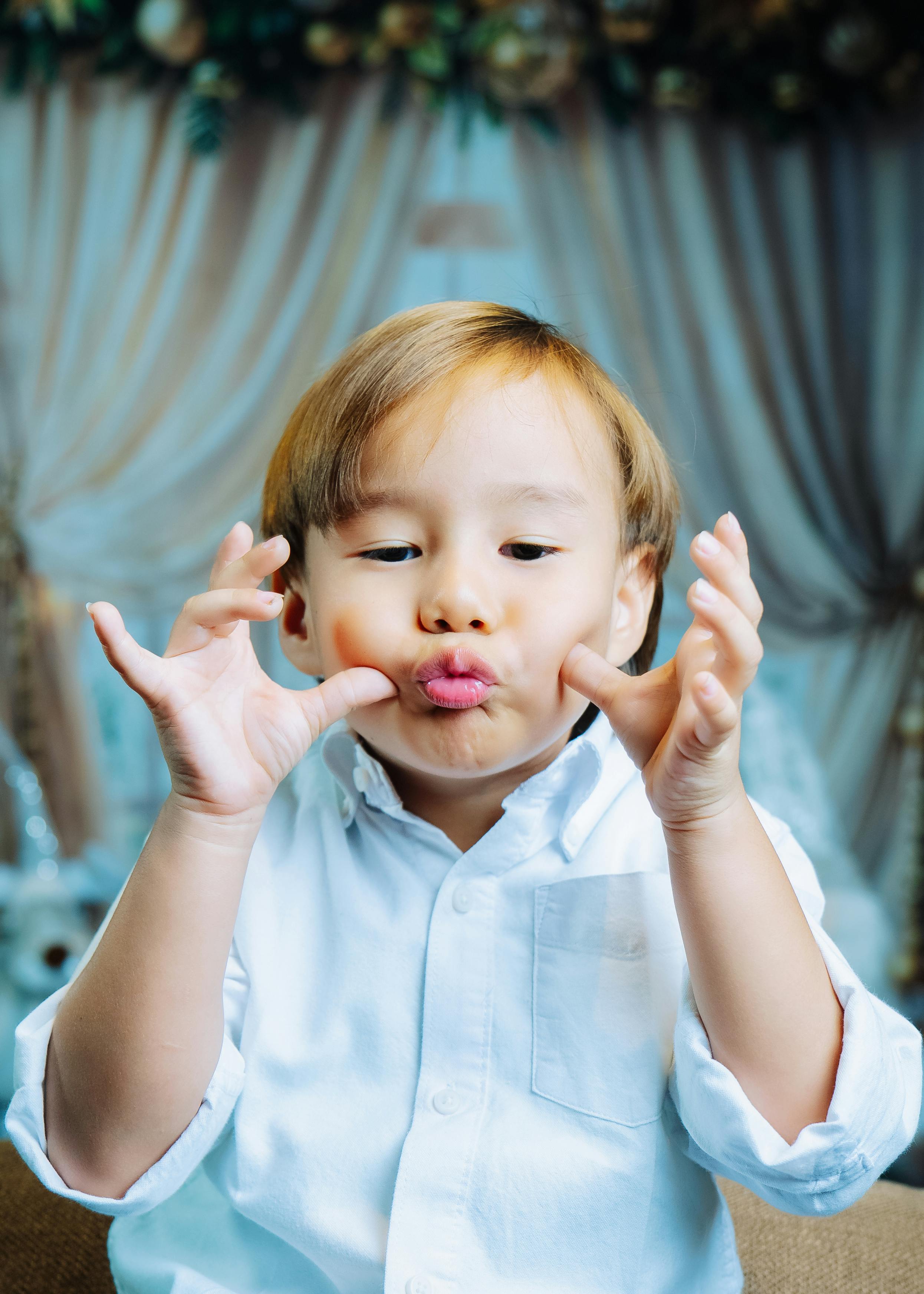 Playful Child Making Silly Faces Indoors · Free Stock Photo