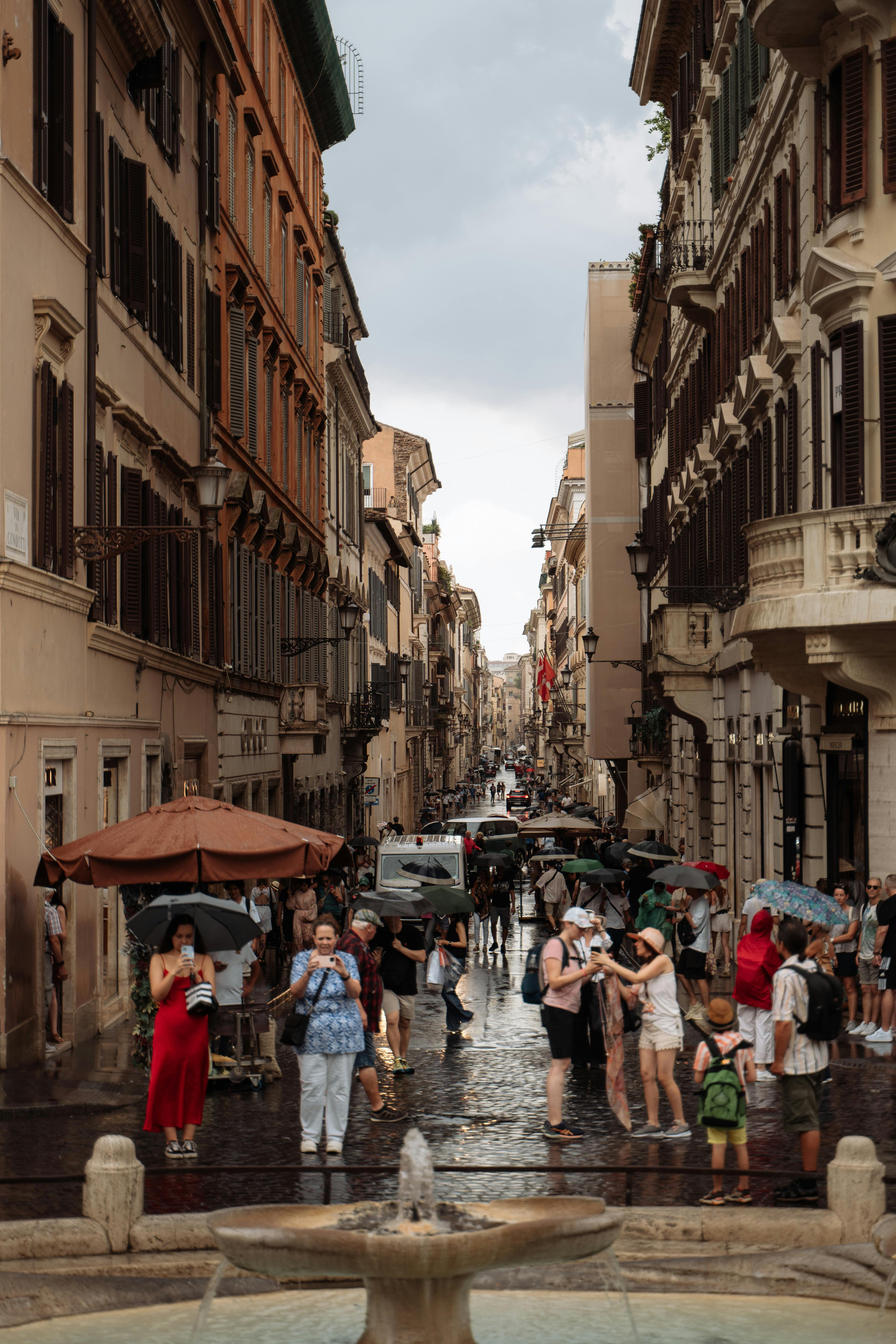 Bustling Street in Rome with Umbrellas · Free Stock Photo