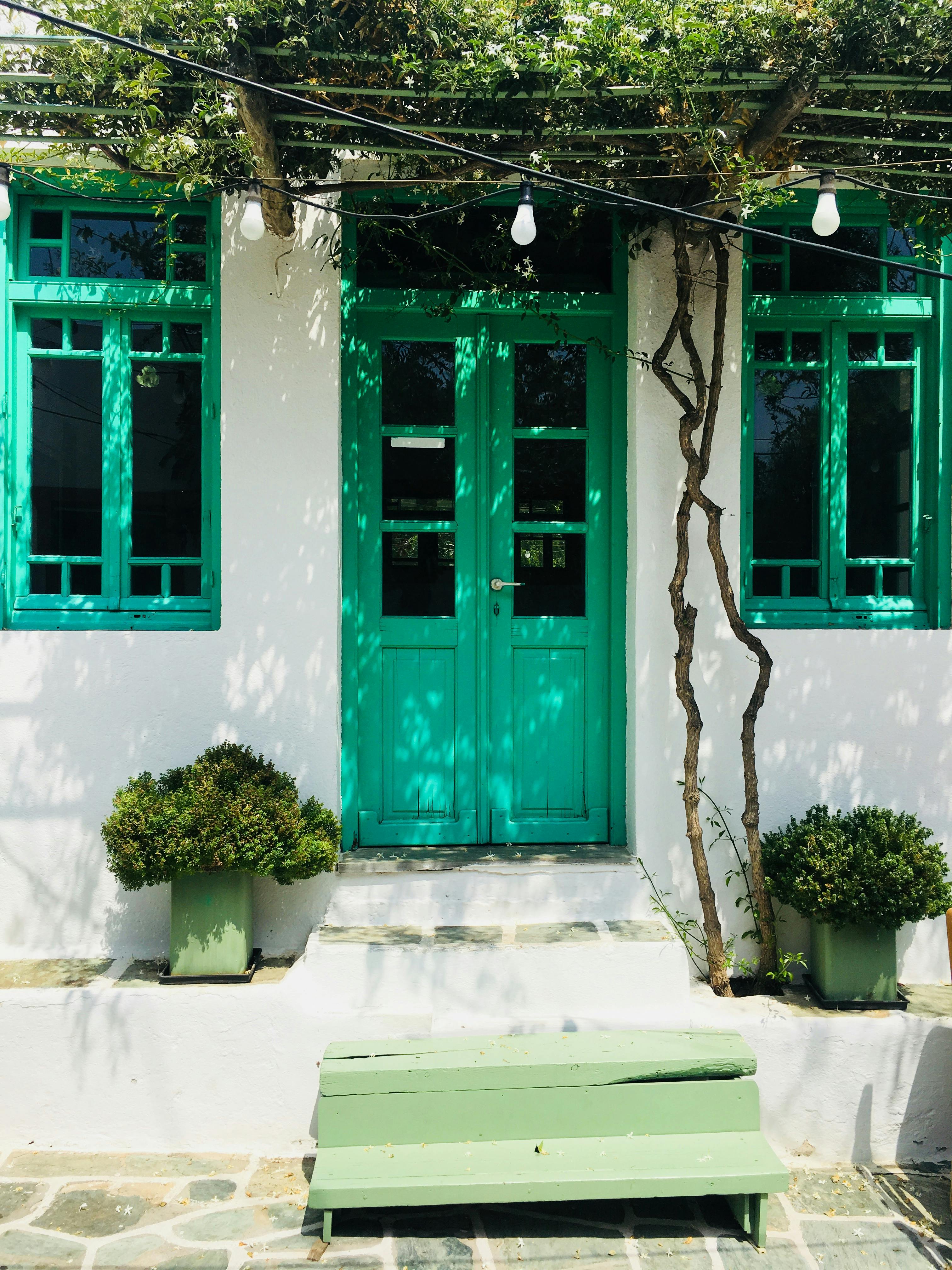 Charming Greek Doorway with Lush Greenery · Free Stock Photo