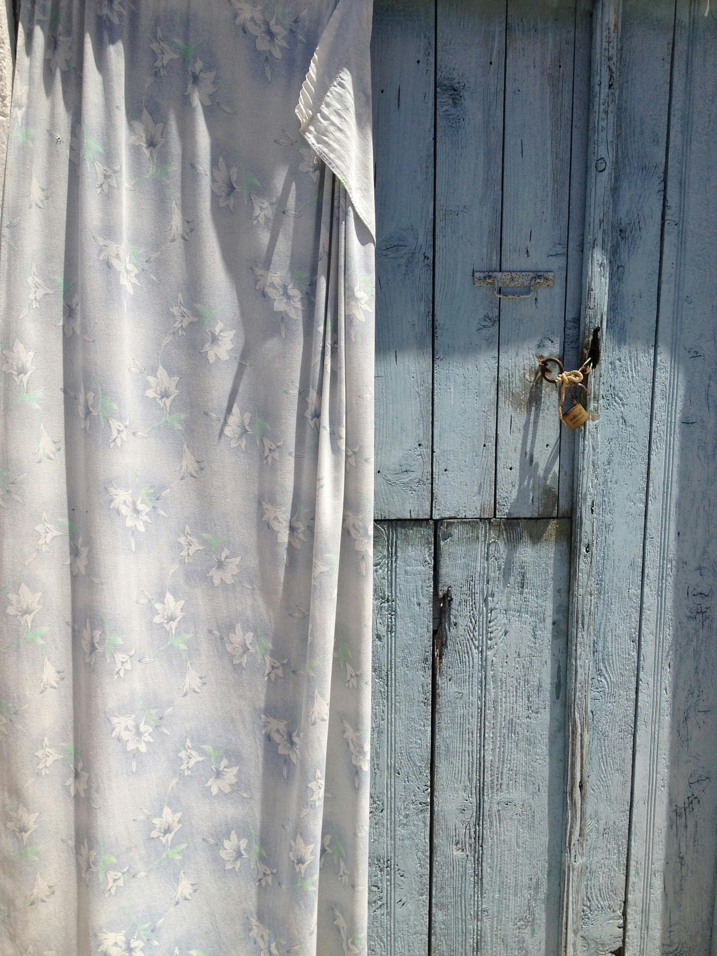 Rustic Blue Door with Floral Curtain in Sunlight · Free Stock Photo