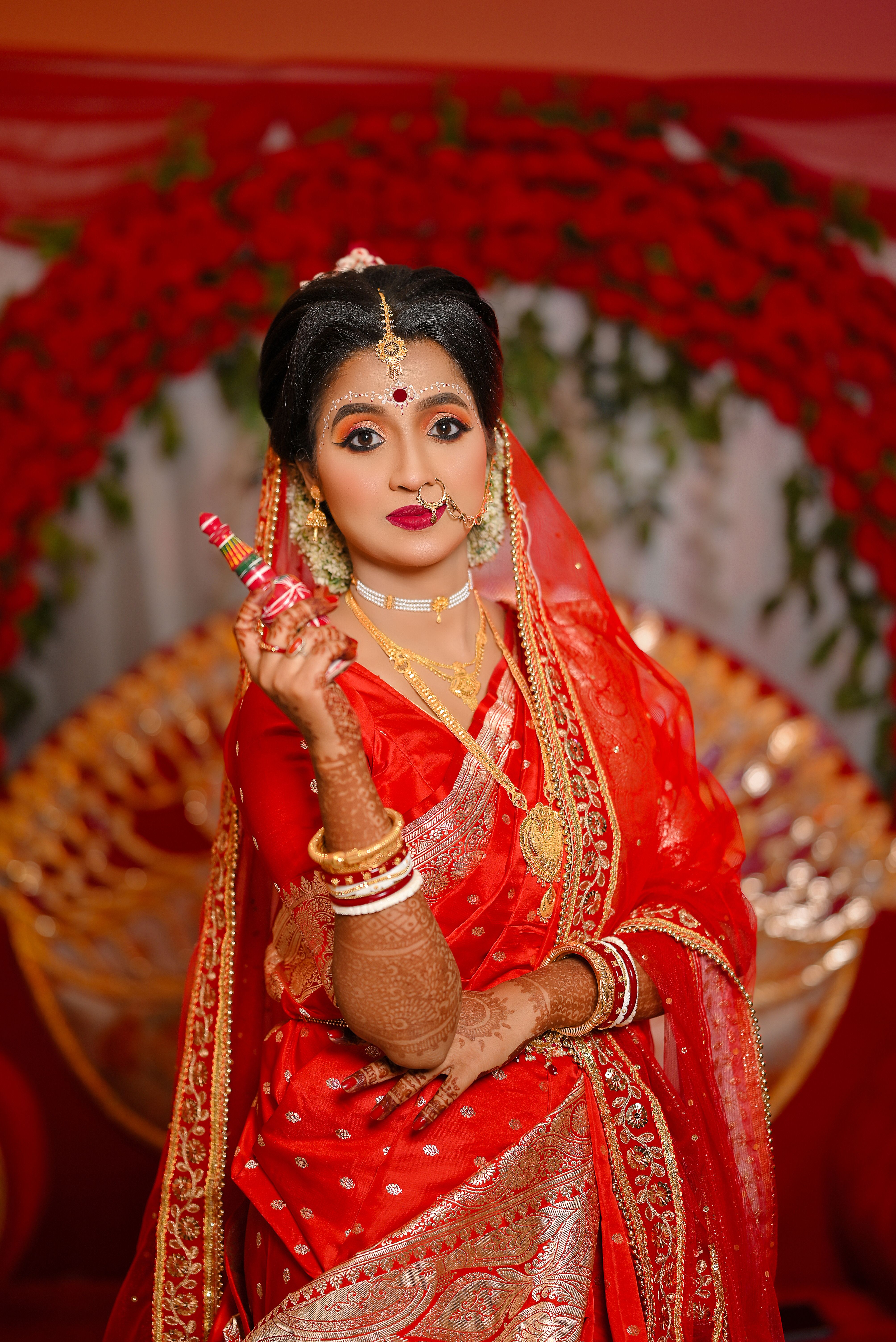 Traditional Indian Bride in Red Saree Holding Sindoor · Free Stock Photo