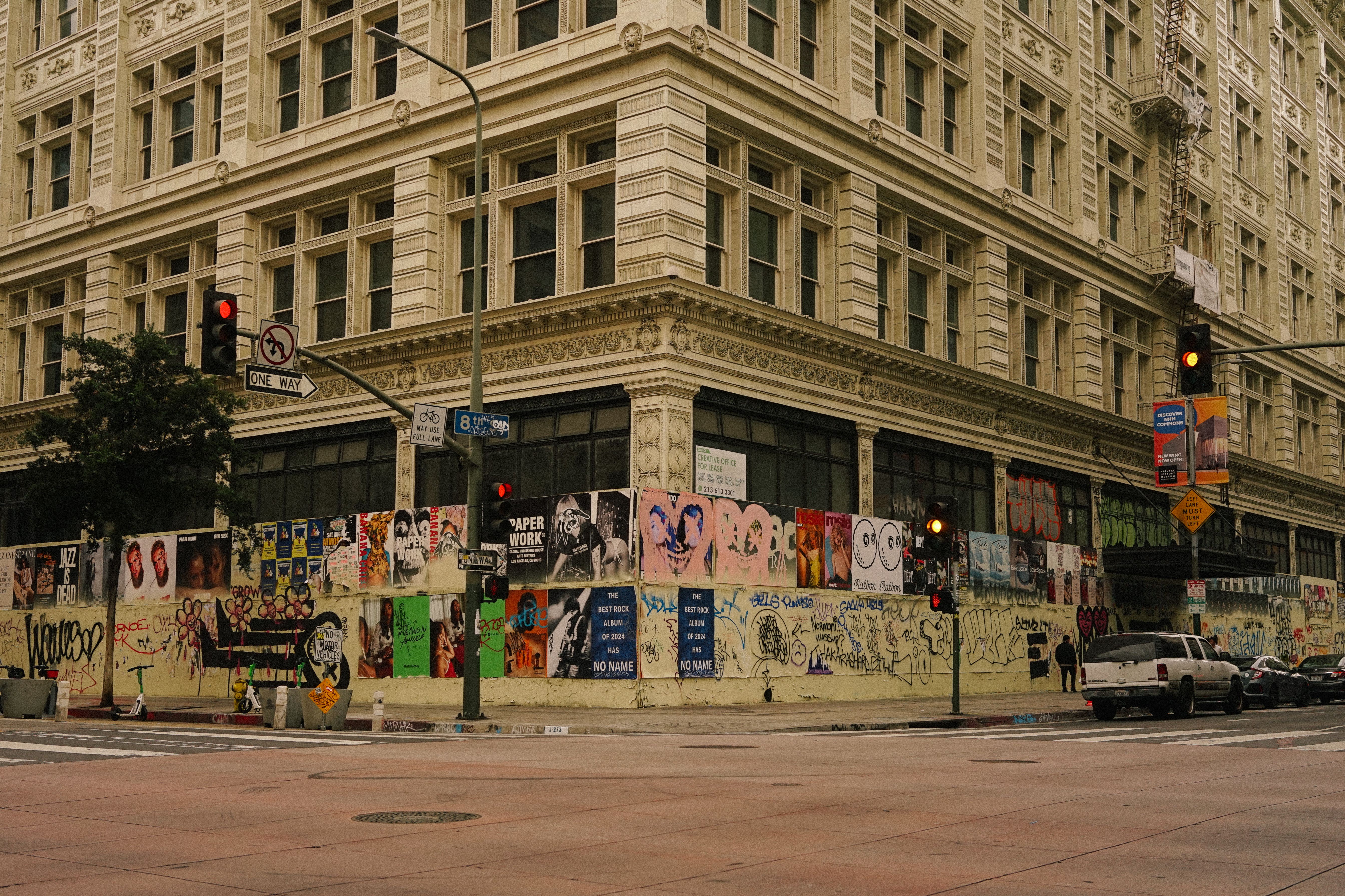 Urban street corner with graffiti and posters · Free Stock Photo