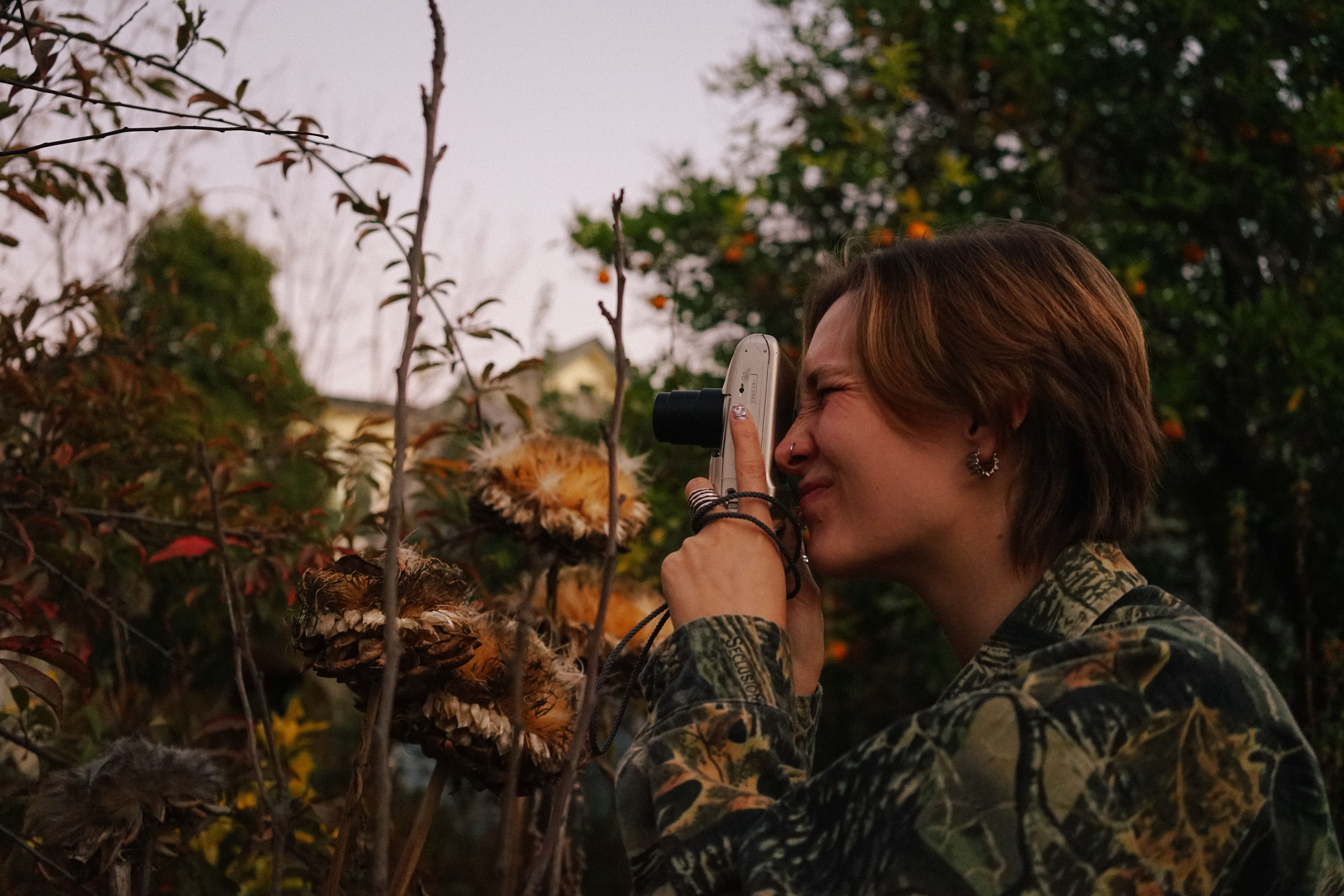 Young Photographer Capturing Nature Scene · Free Stock Photo