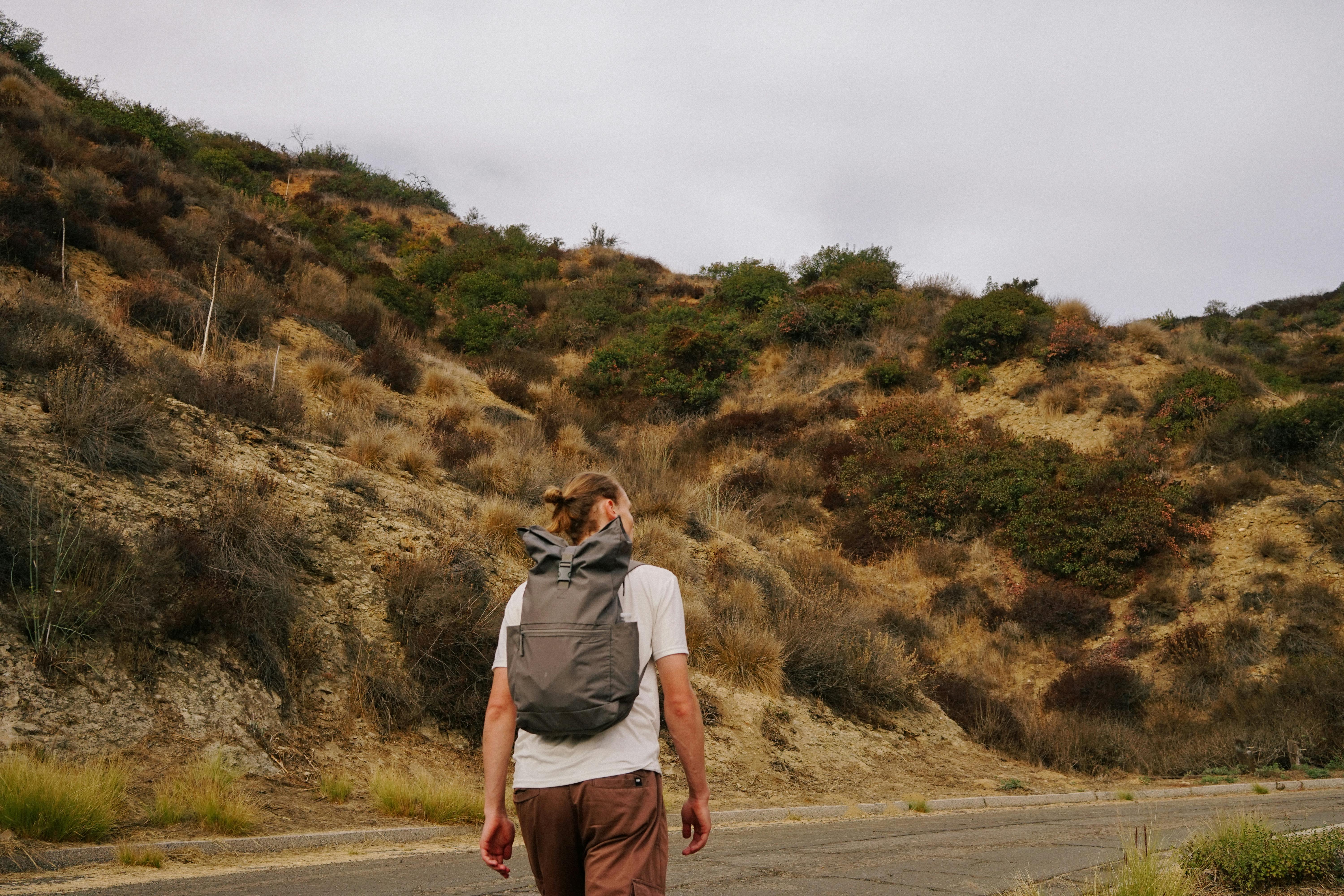 Backpacker Exploring Mountainous Terrain · Free Stock Photo