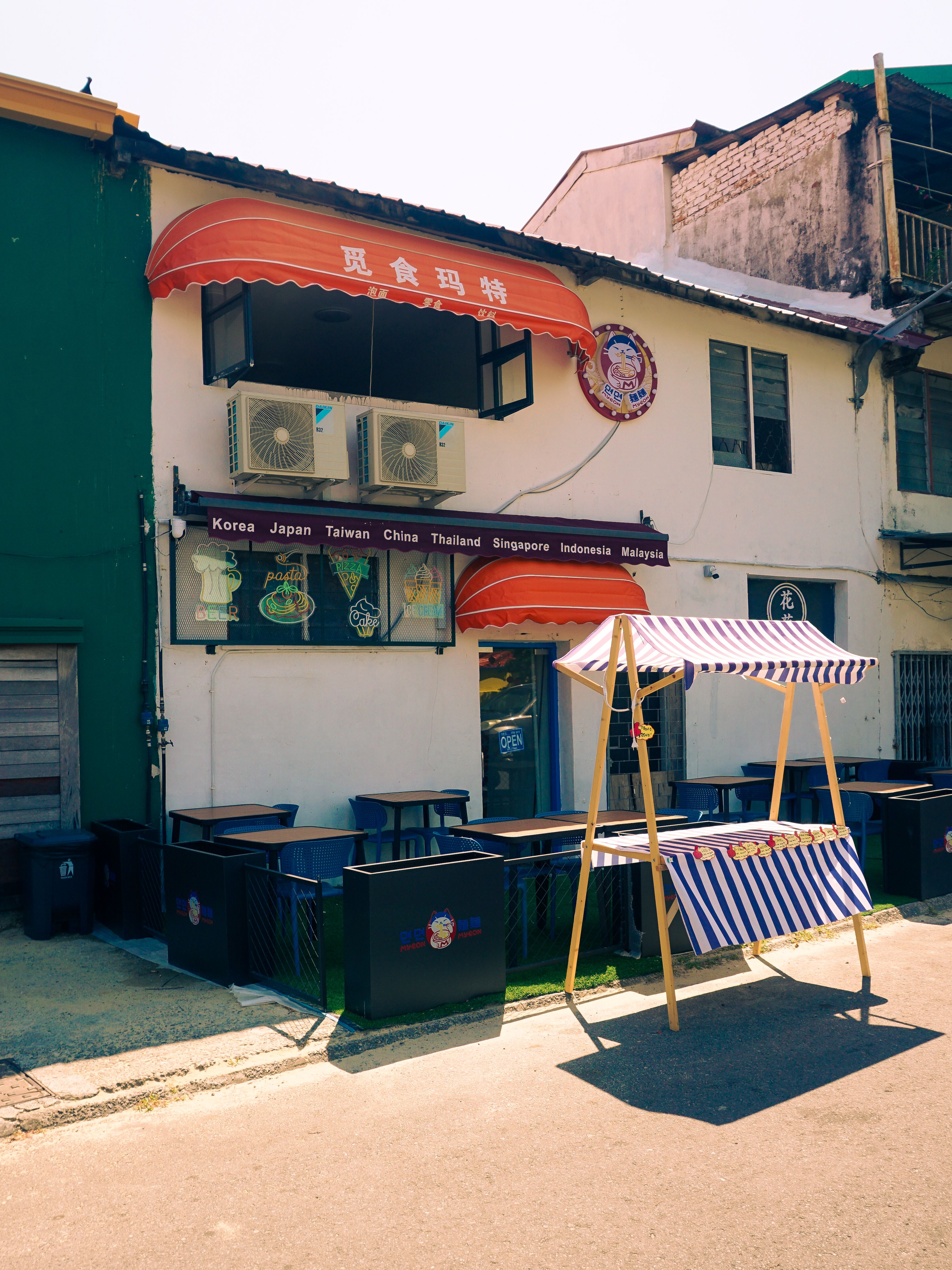 Street View of Asian Restaurant with Colorful Awning · Free Stock Photo