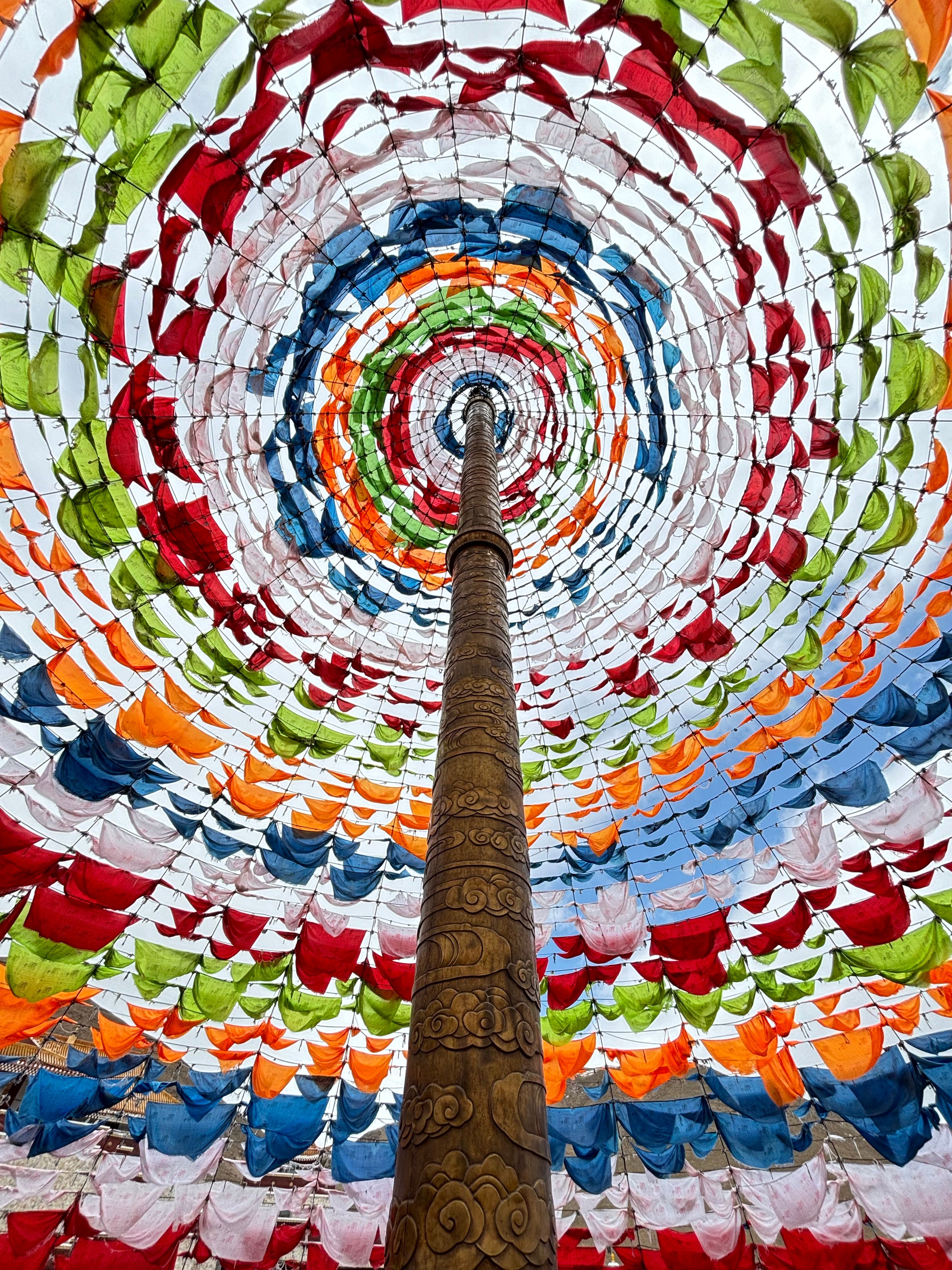 Vibrant Prayer Flags Spiral with Central Pole · Free Stock Photo