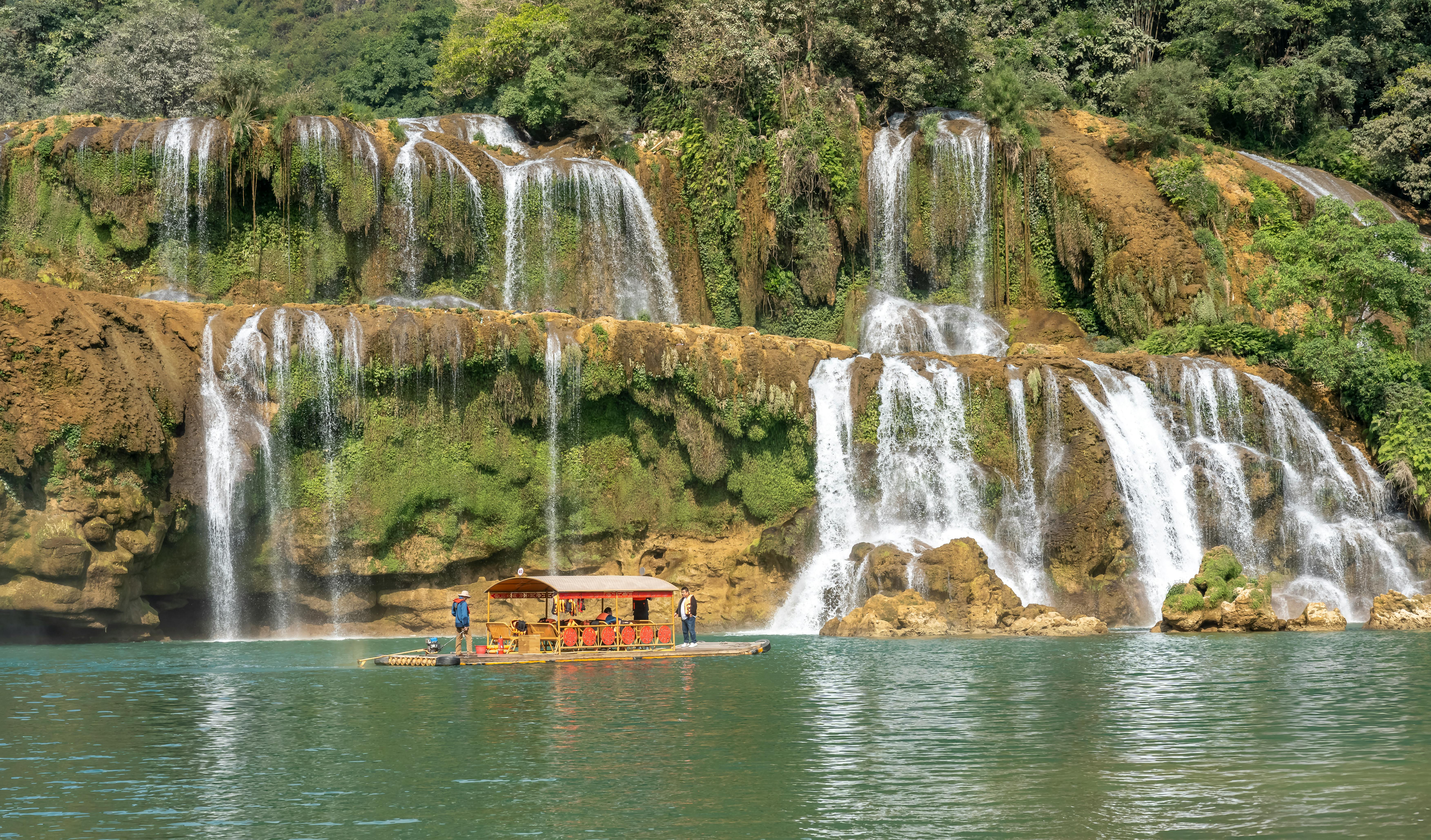 Scenic Waterfall with Tourist Boat in Nature · Free Stock Photo