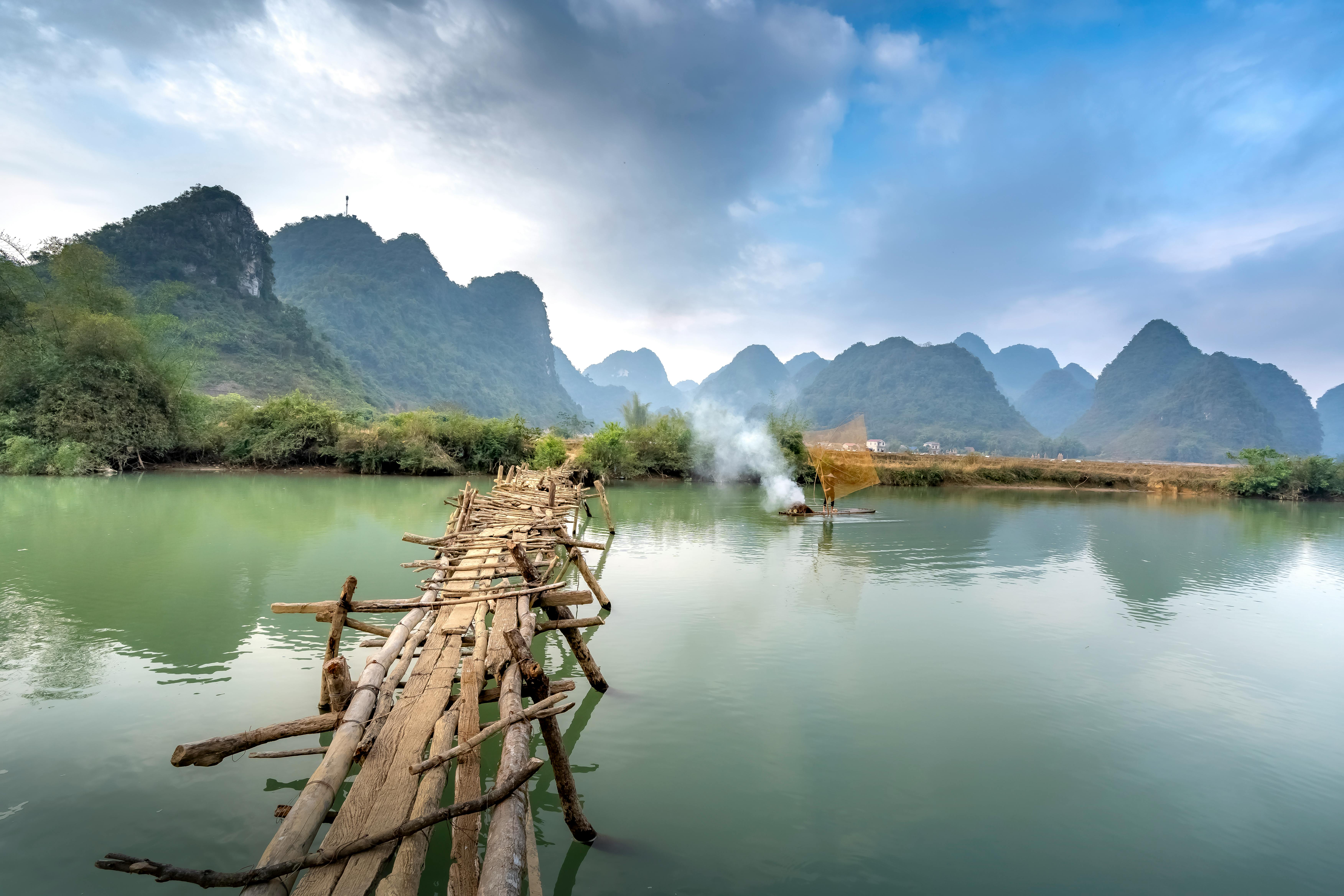 Scenic Bamboo Bridge with Karst Mountains · Free Stock Photo