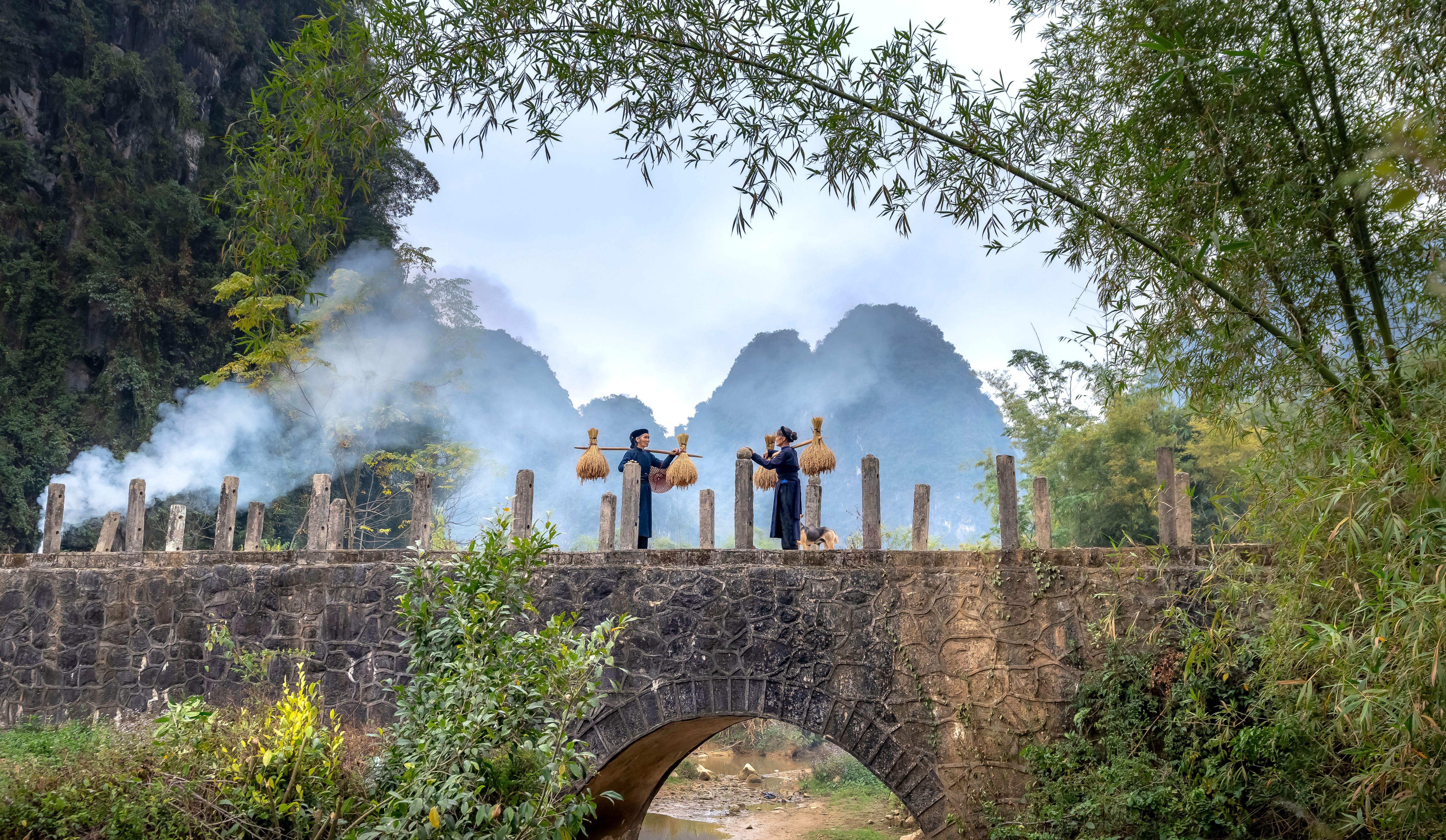 Traditional Farmers on Historic Stone Bridge · Free Stock Photo
