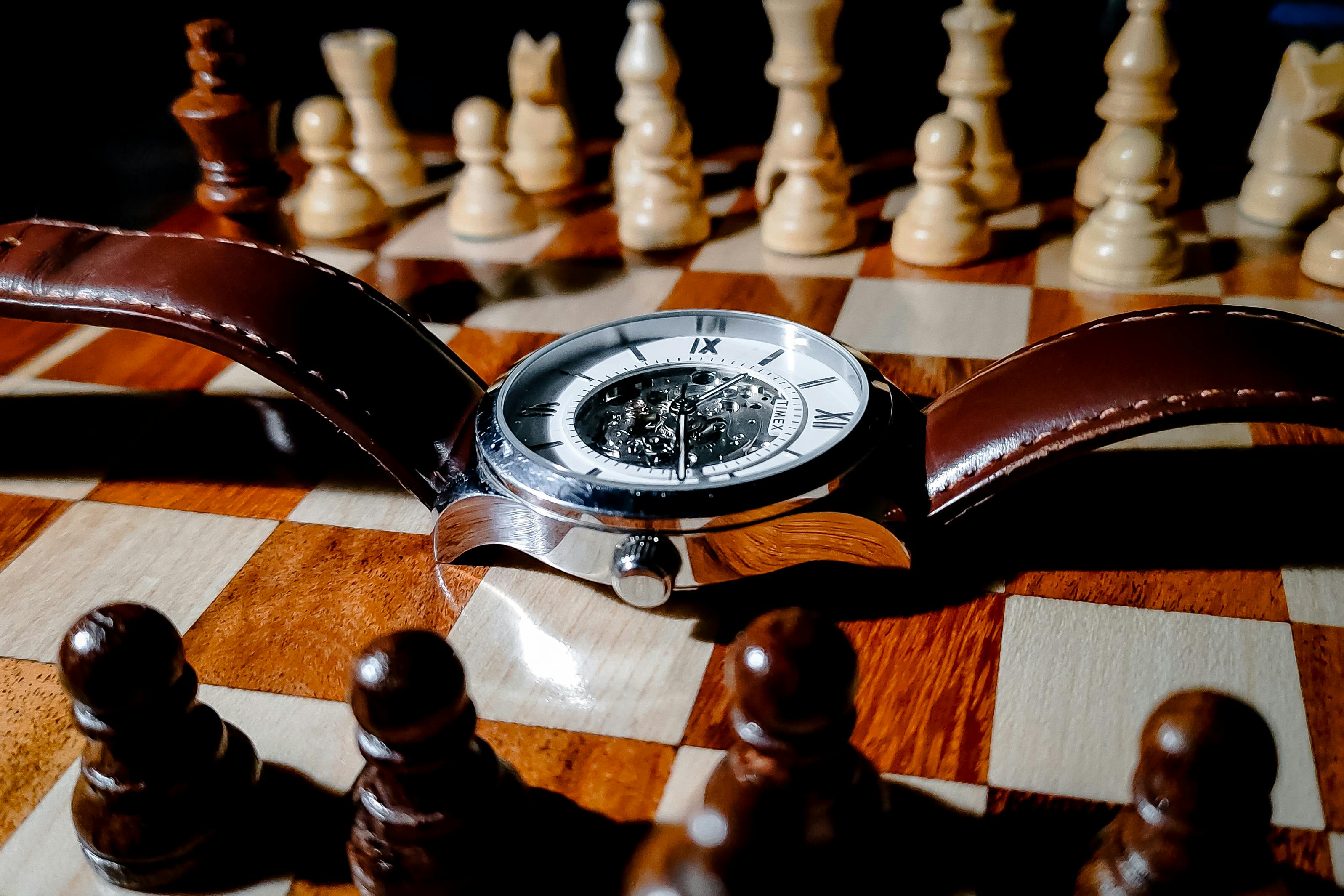 Elegant Watch on Chessboard with Pieces · Free Stock Photo