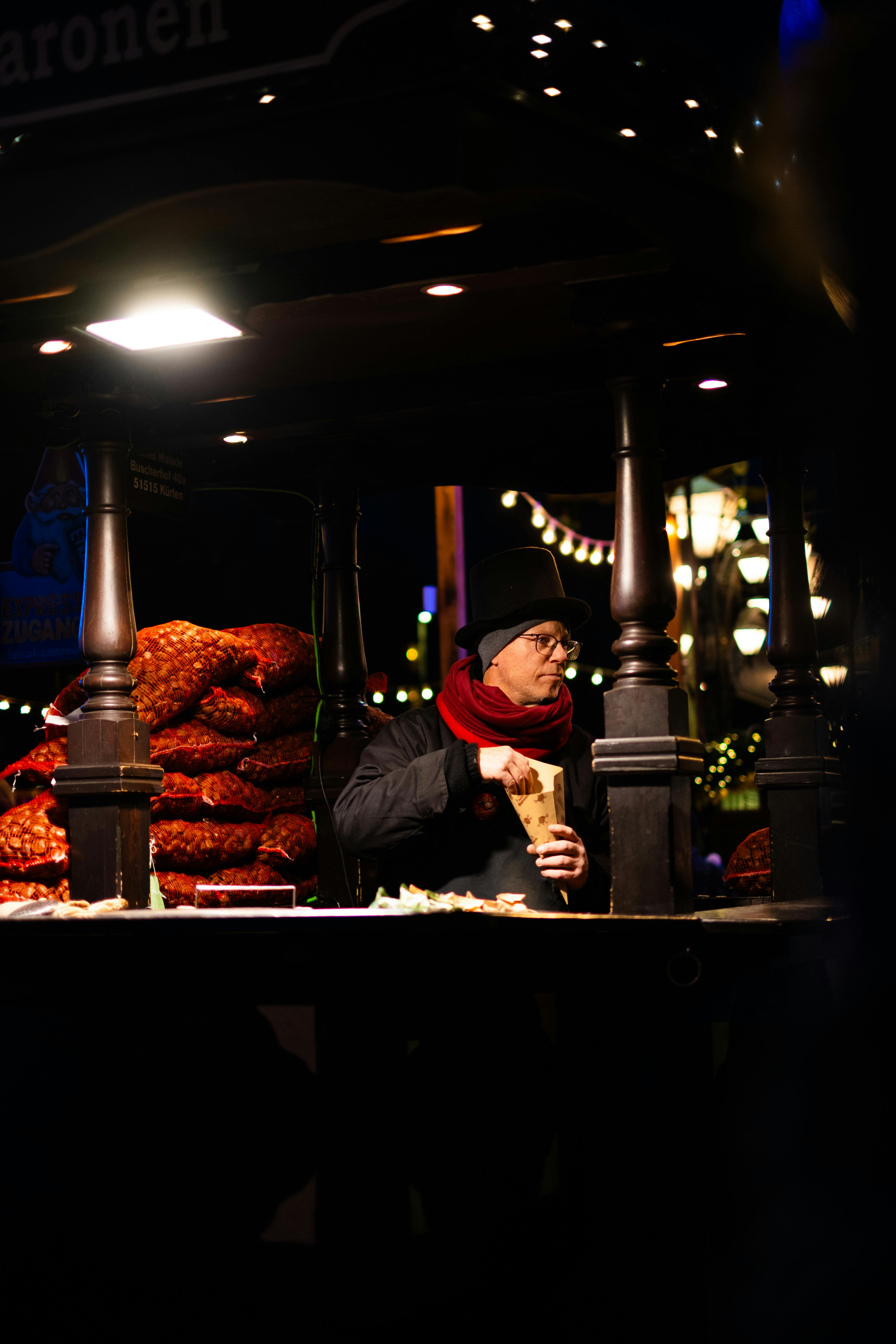 Night Market Vendor at Festive Stall · Free Stock Photo