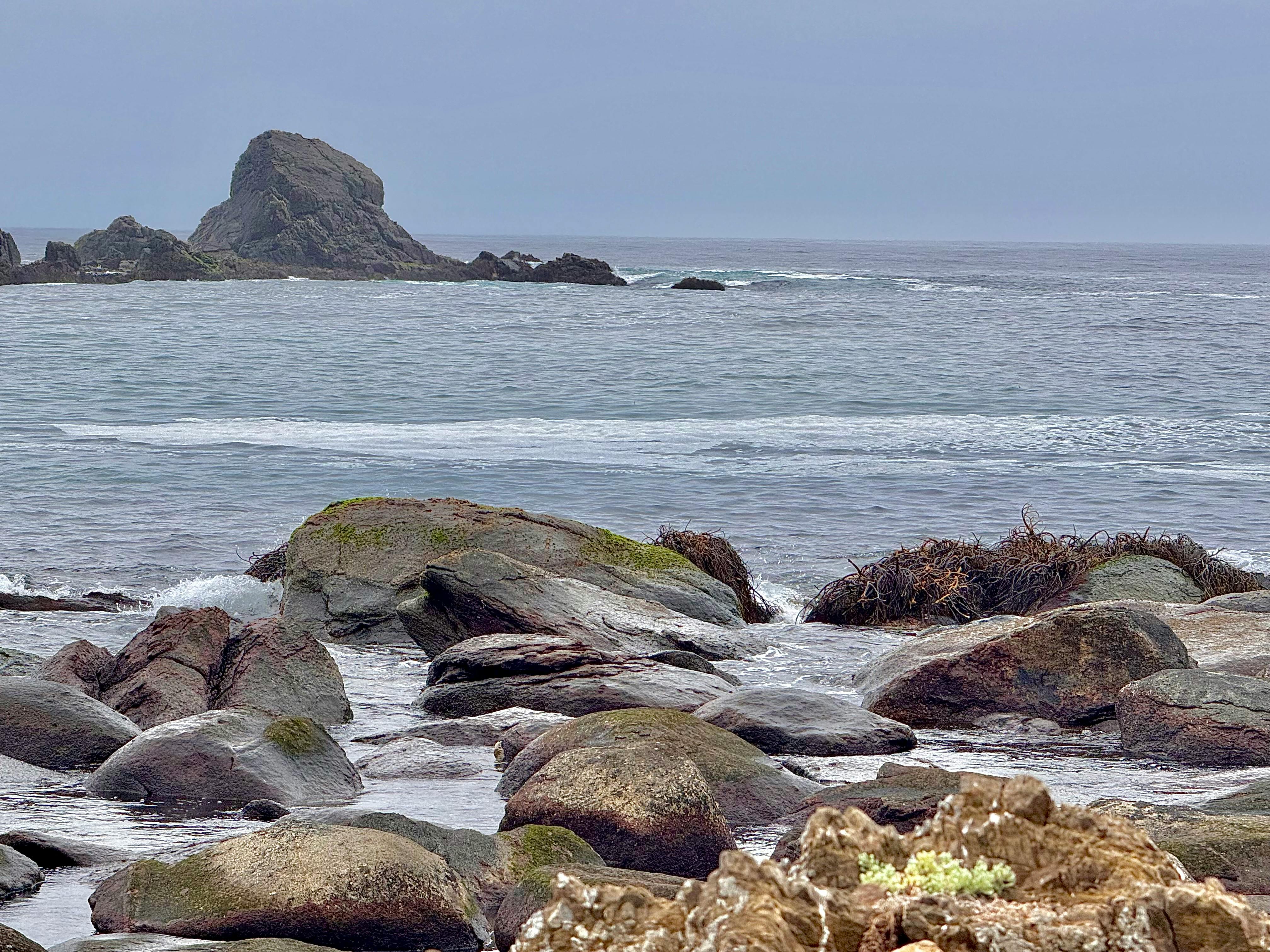 Rocky Ocean Shoreline Under Cloudy Sky · Free Stock Photo