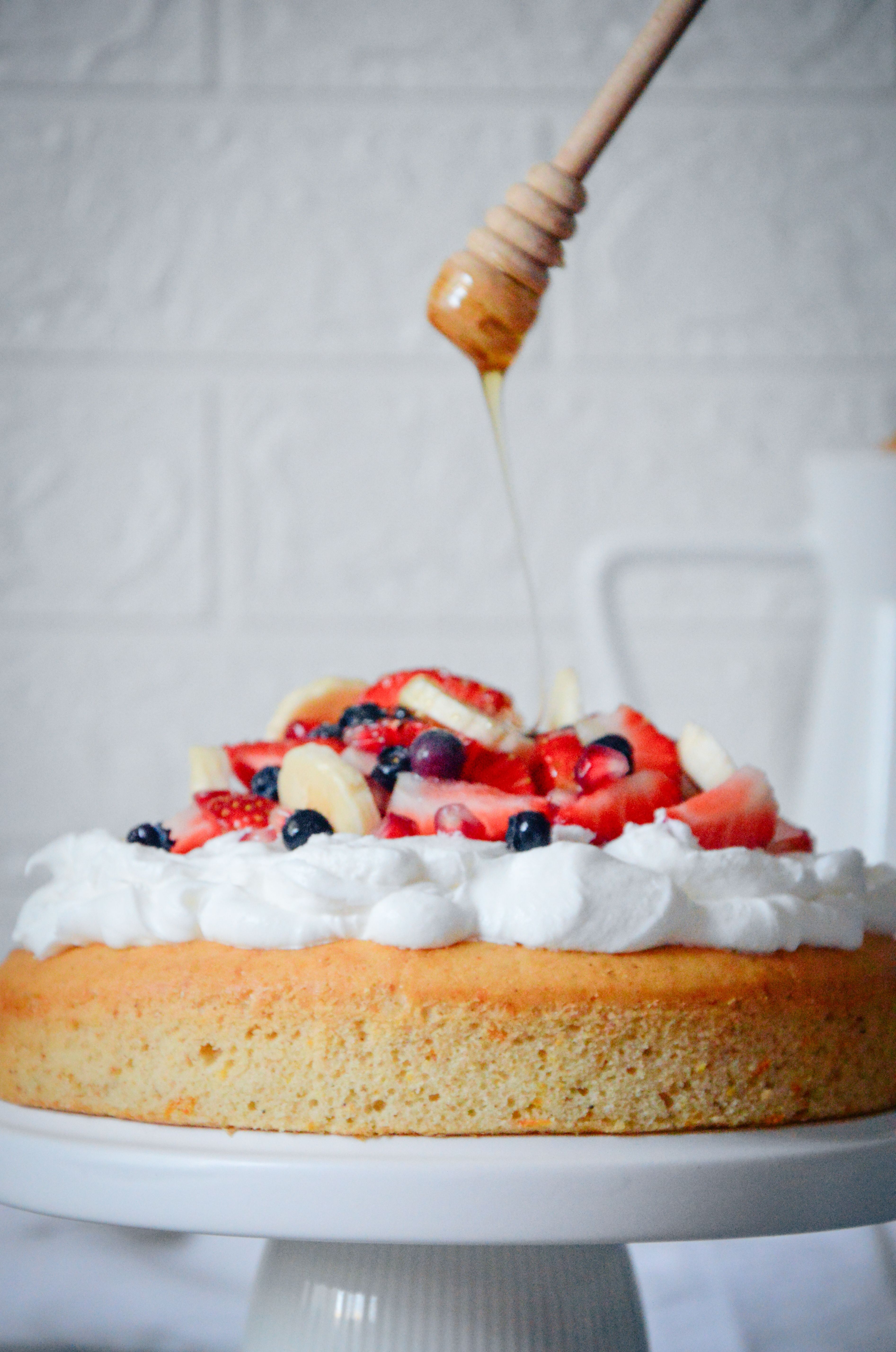 Delicious Fruit-Topped Sponge Cake with Honey Drizzle · Free Stock Photo