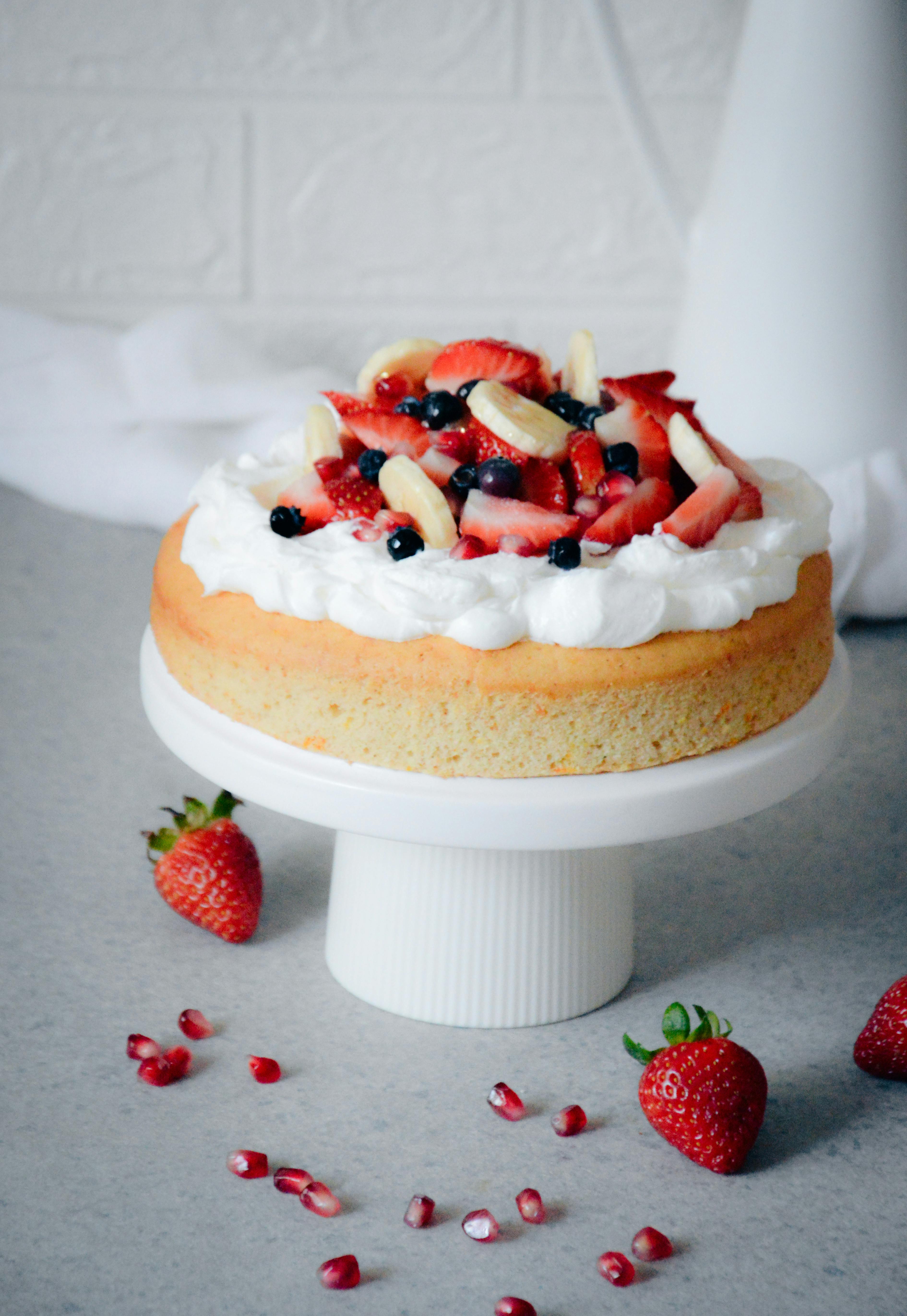 Delicious Fruit Topped Cheesecake on Stand · Free Stock Photo