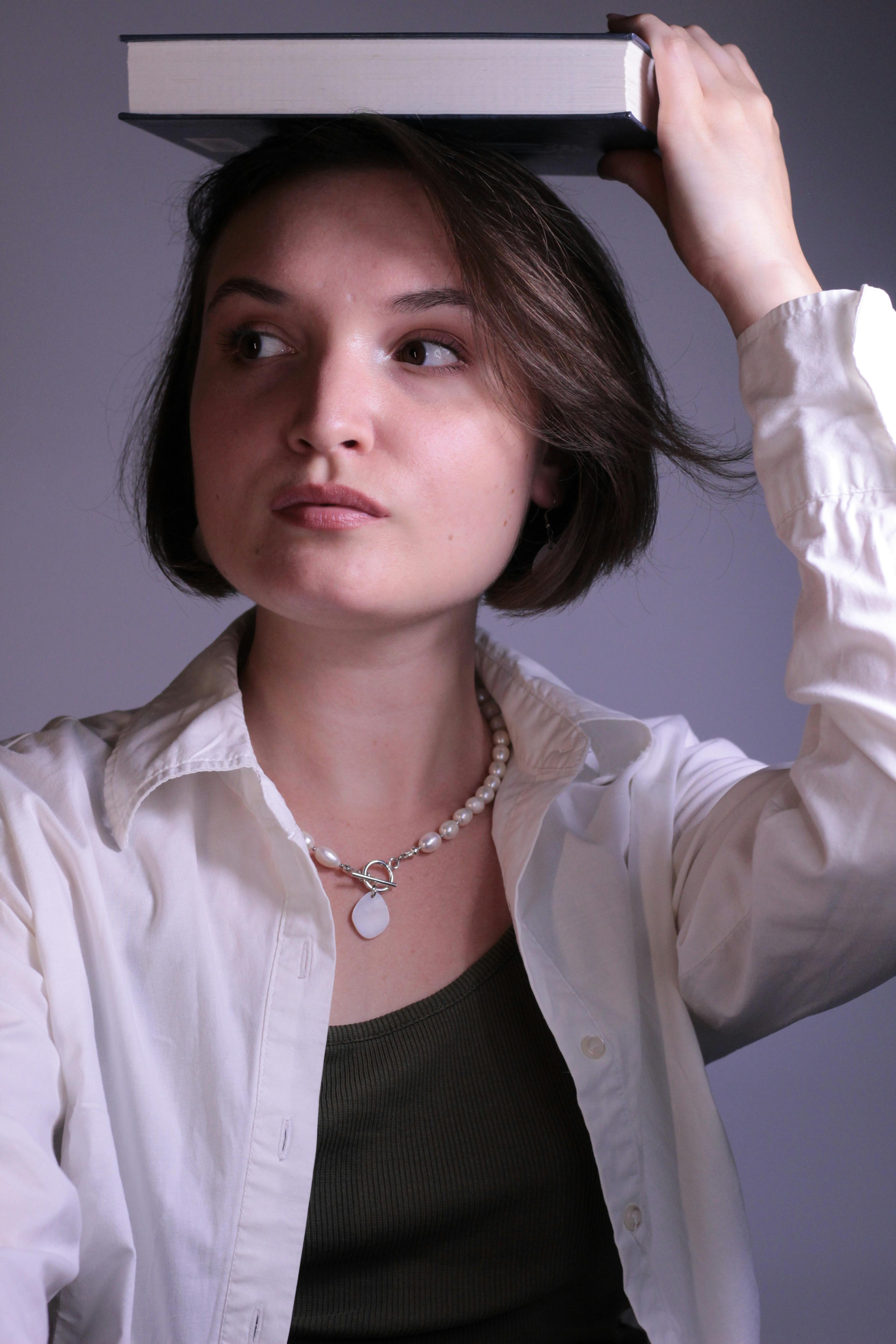 Young Woman Balancing Book on Head · Free Stock Photo