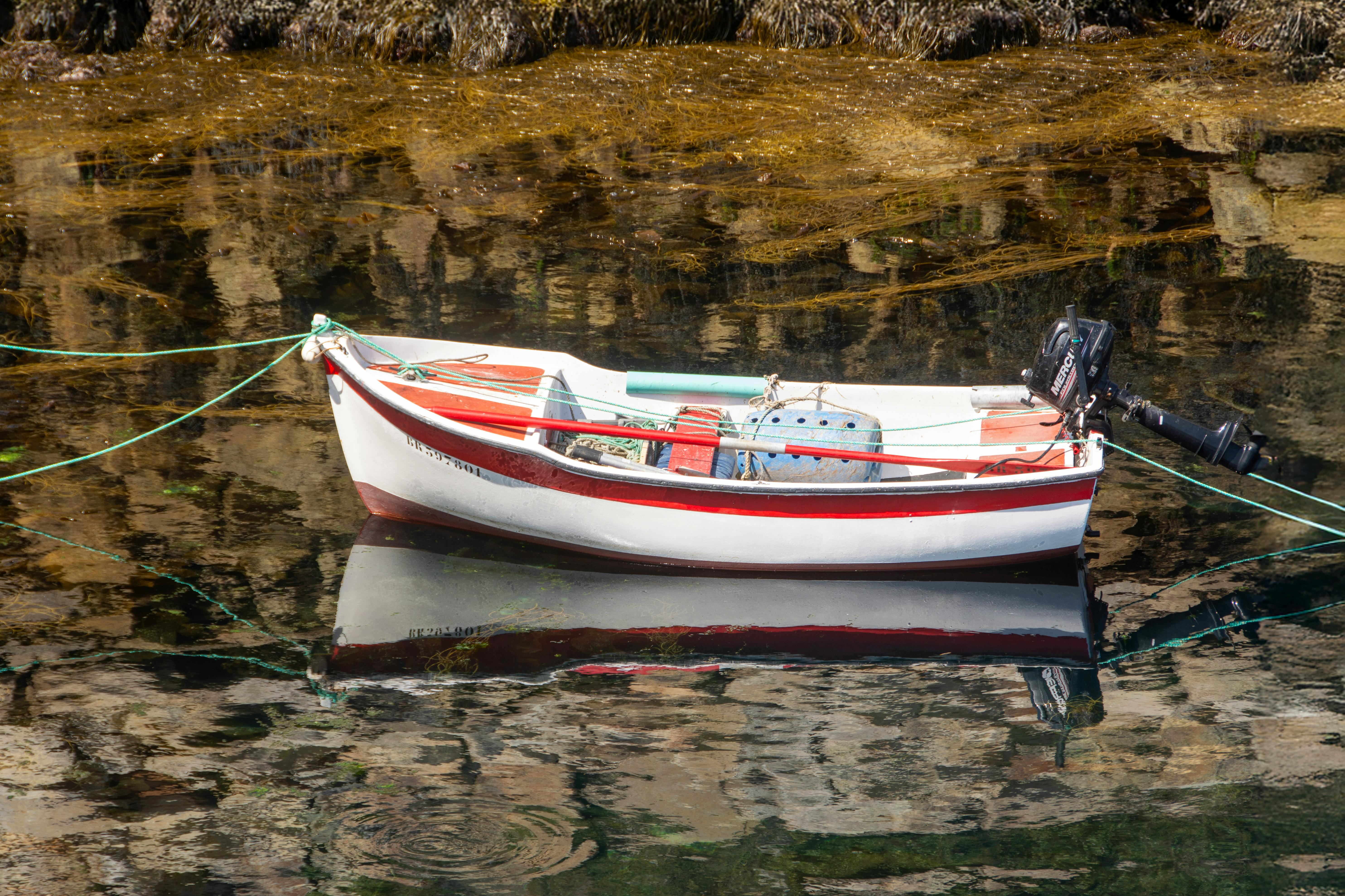 Small Rowboat with Engine on Still Water · Free Stock Photo