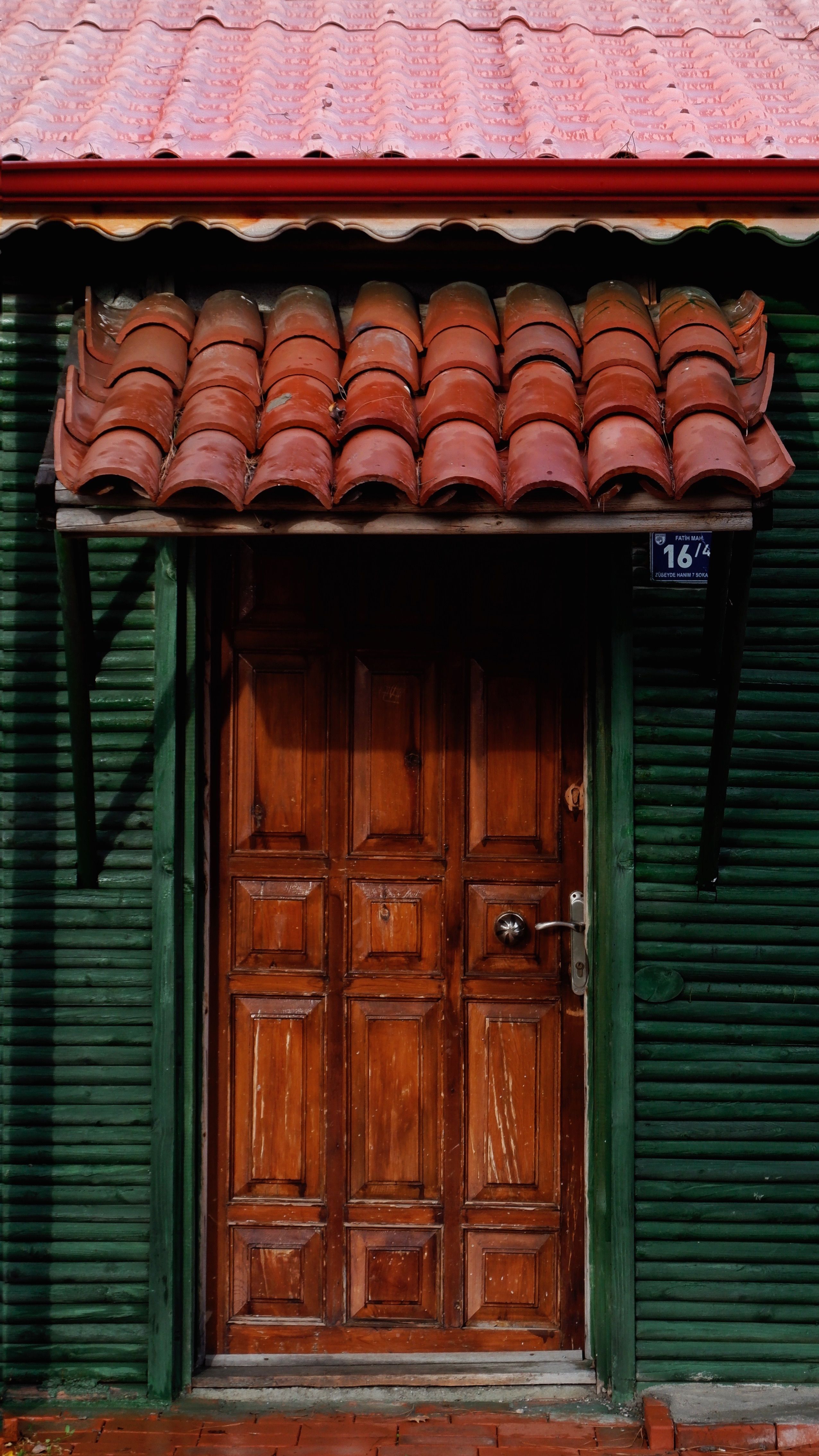 Traditional Wooden Door with Clay Tile Roof · Free Stock Photo