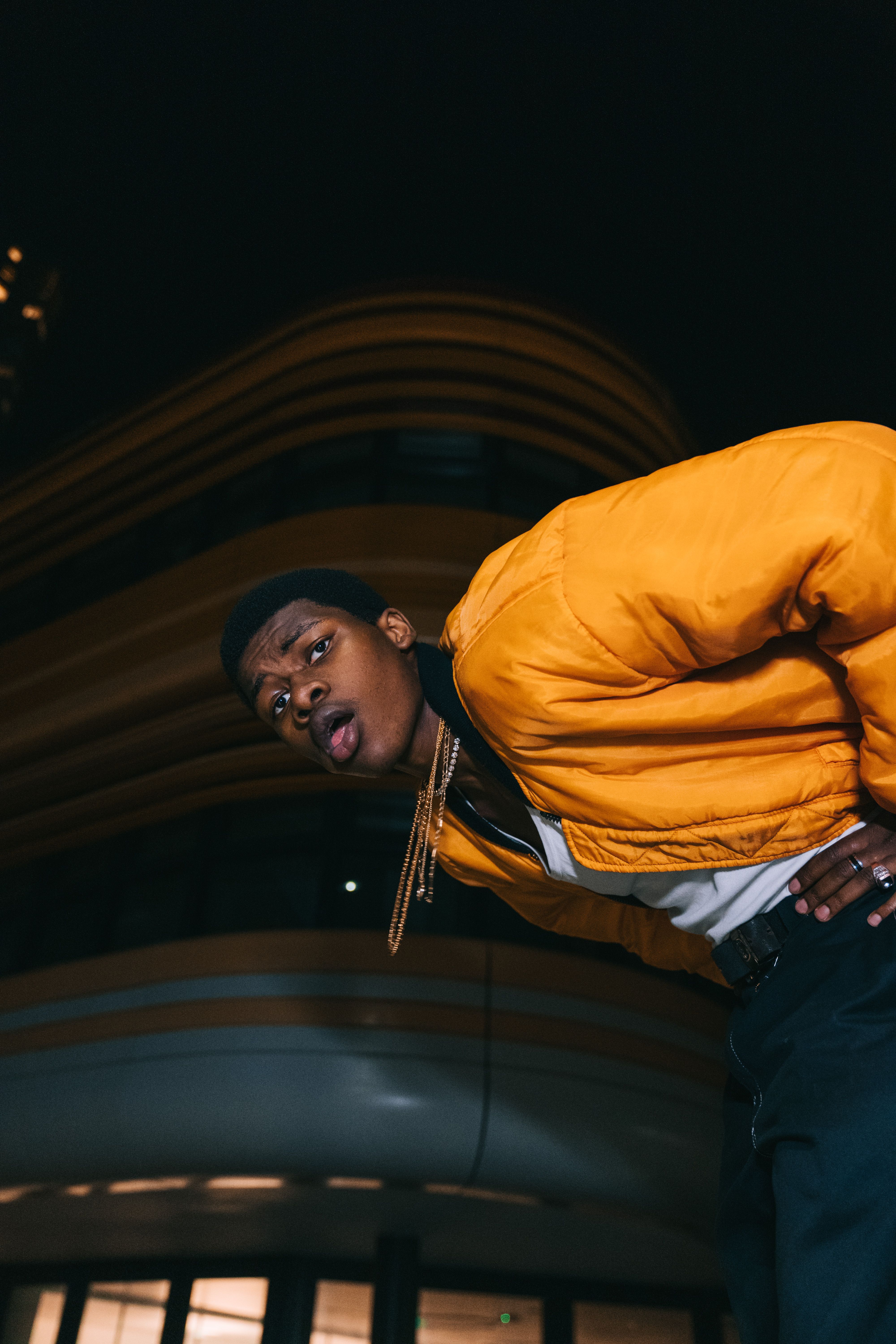Young Man in Yellow Jacket at Night in Paris · Free Stock Photo