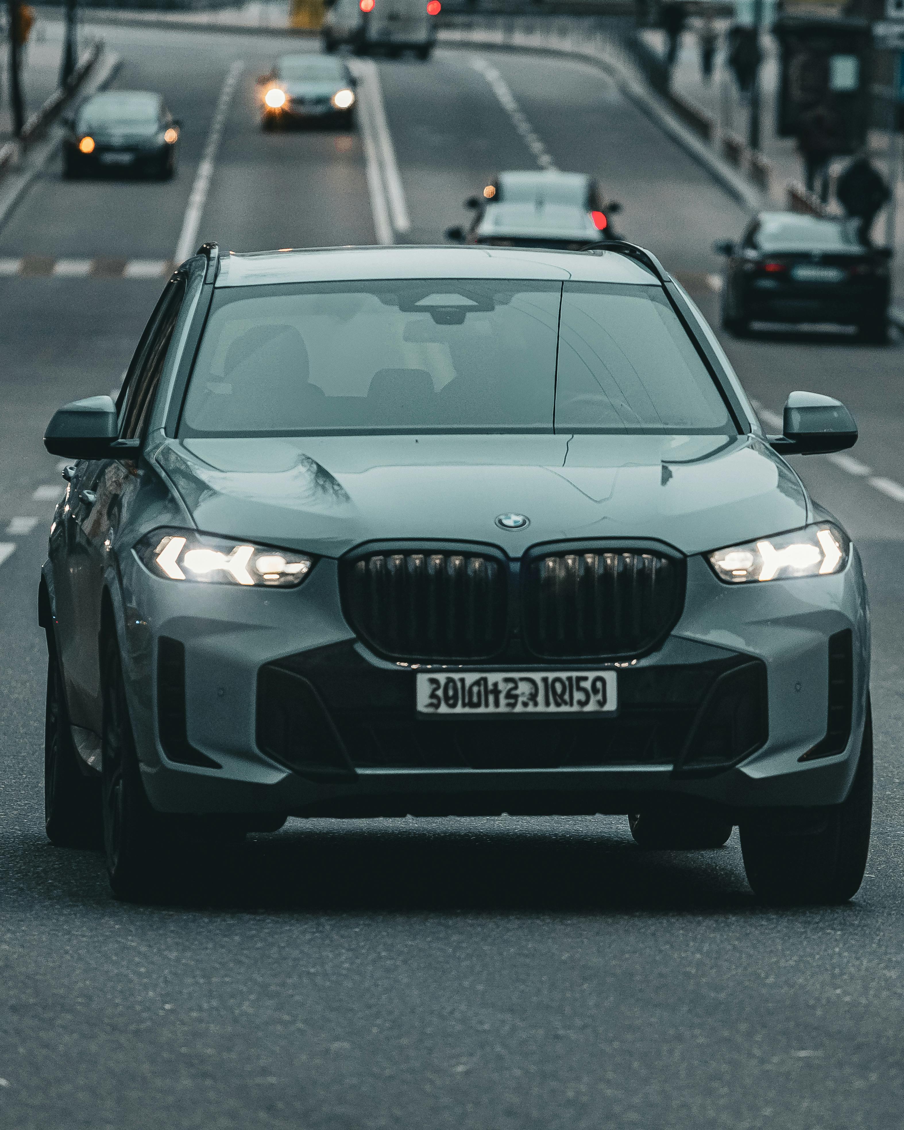 Luxury Car Driving on Urban Street at Daytime · Free Stock Photo