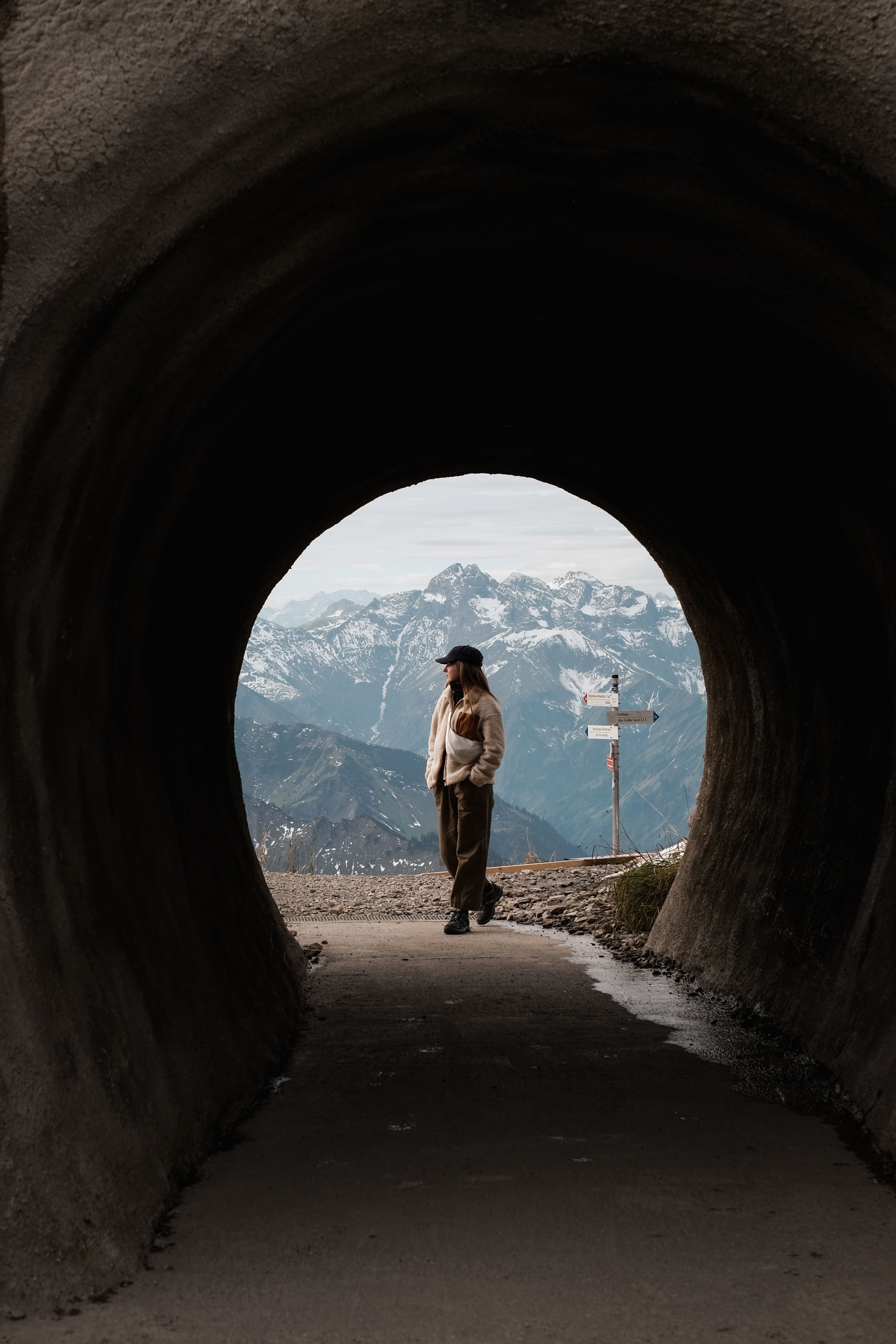 Person Walking Through Tunnel to Mountain View · Free Stock Photo