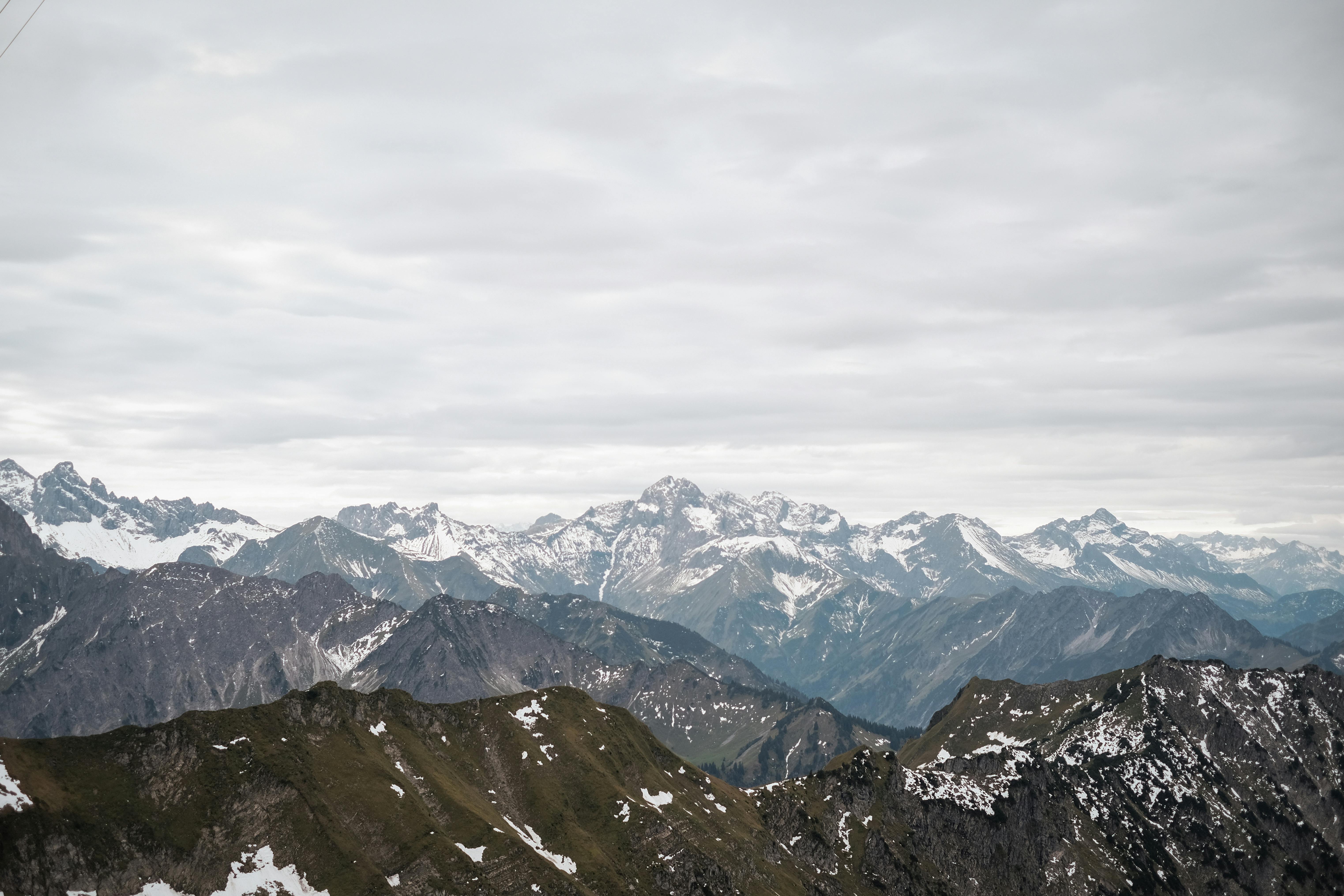 Stunning Alpine Mountain Range Under Cloudy Sky · Free Stock Photo