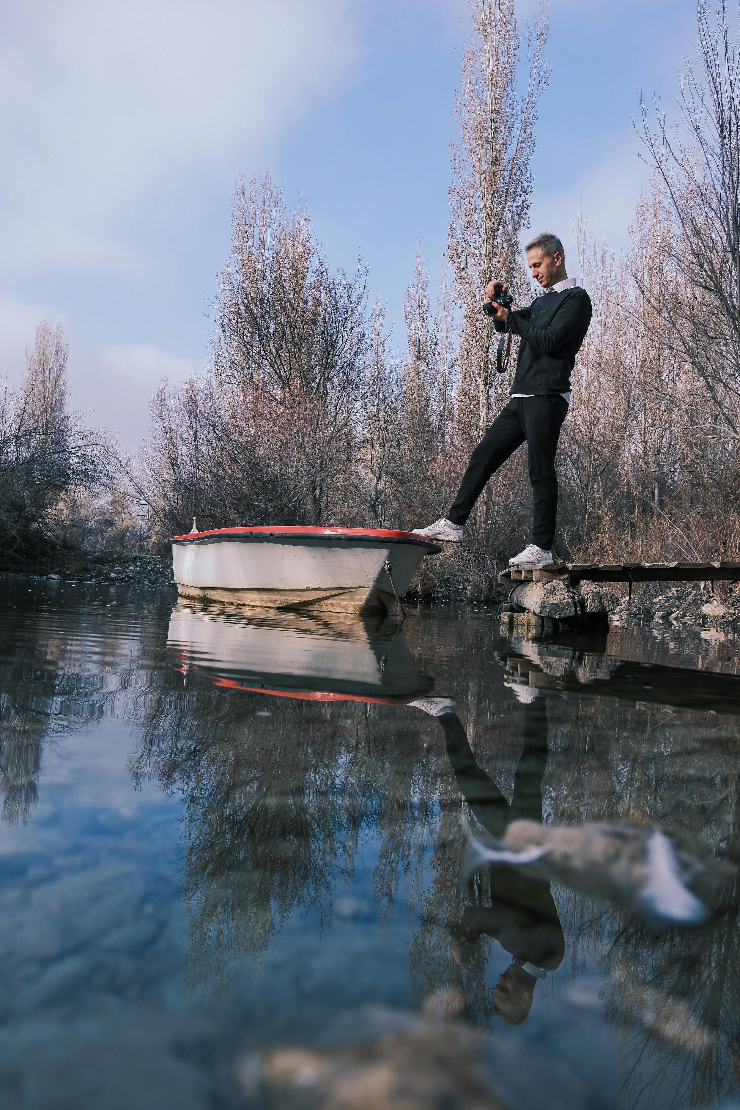 Man Photographing Scenic Winter Lake View · Free Stock Photo