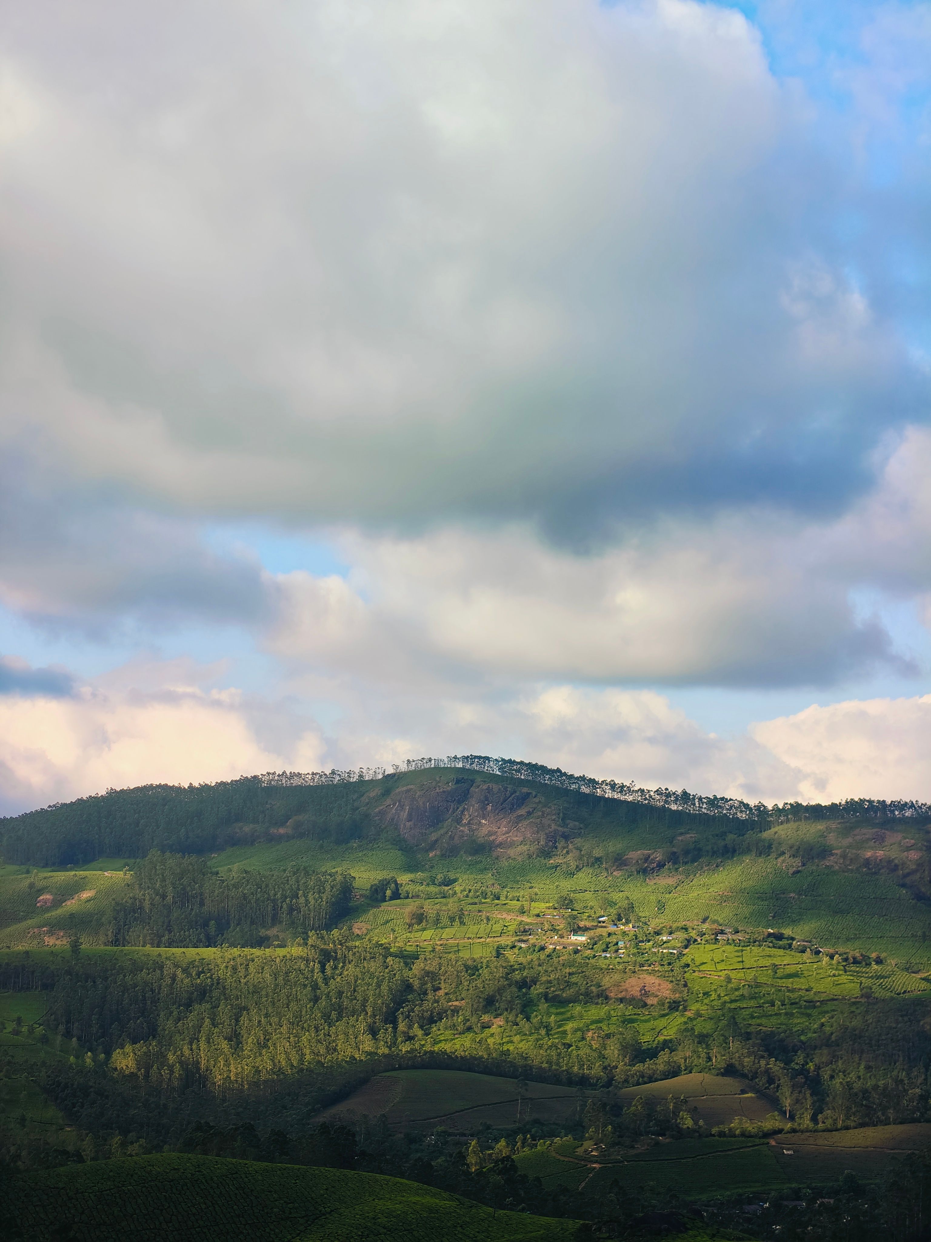 Scenic Hills of Munnar Under a Cloudy Sky · Free Stock Photo