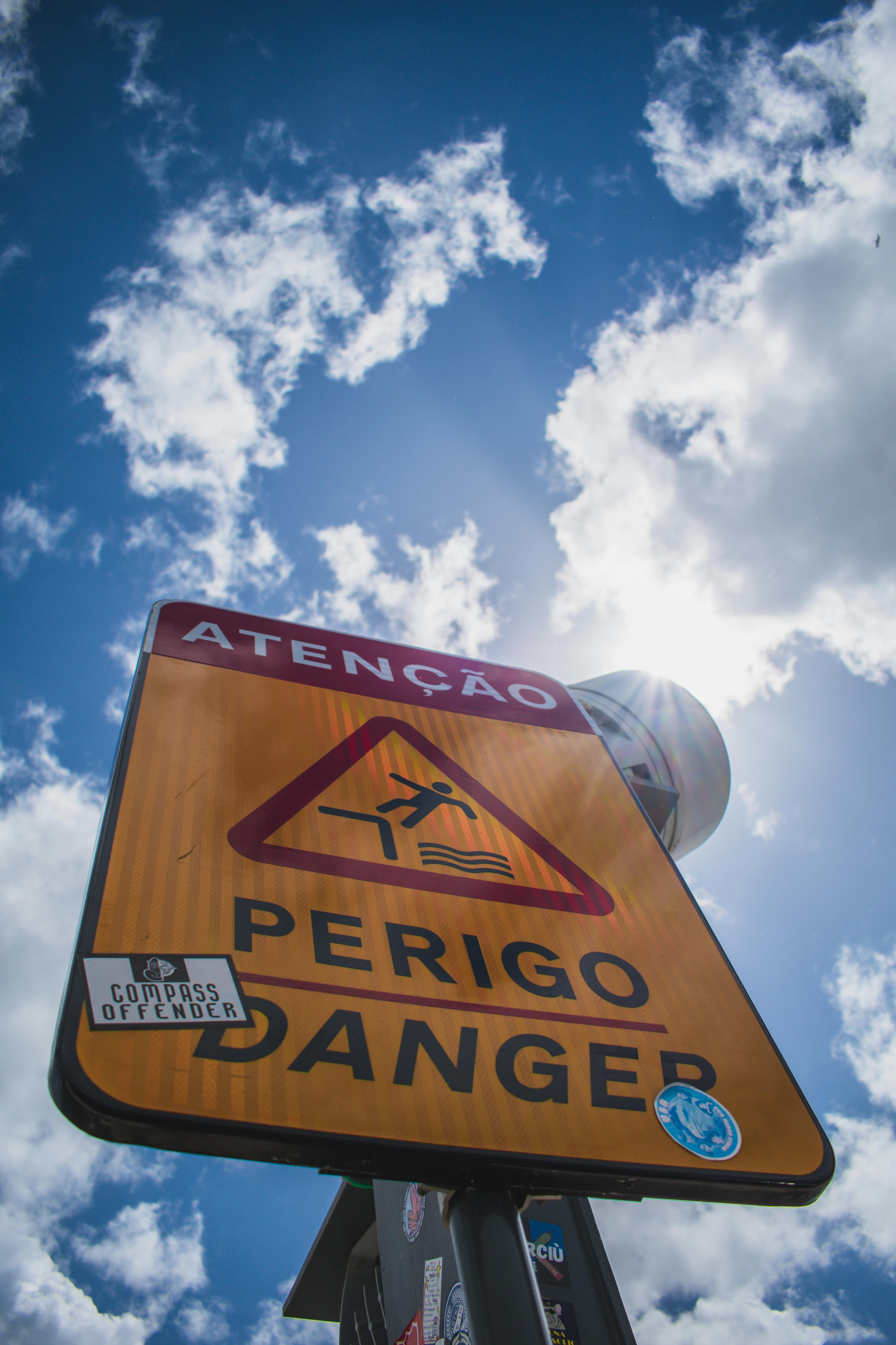 Warning Sign Against Blue Sky in Brazil · Free Stock Photo
