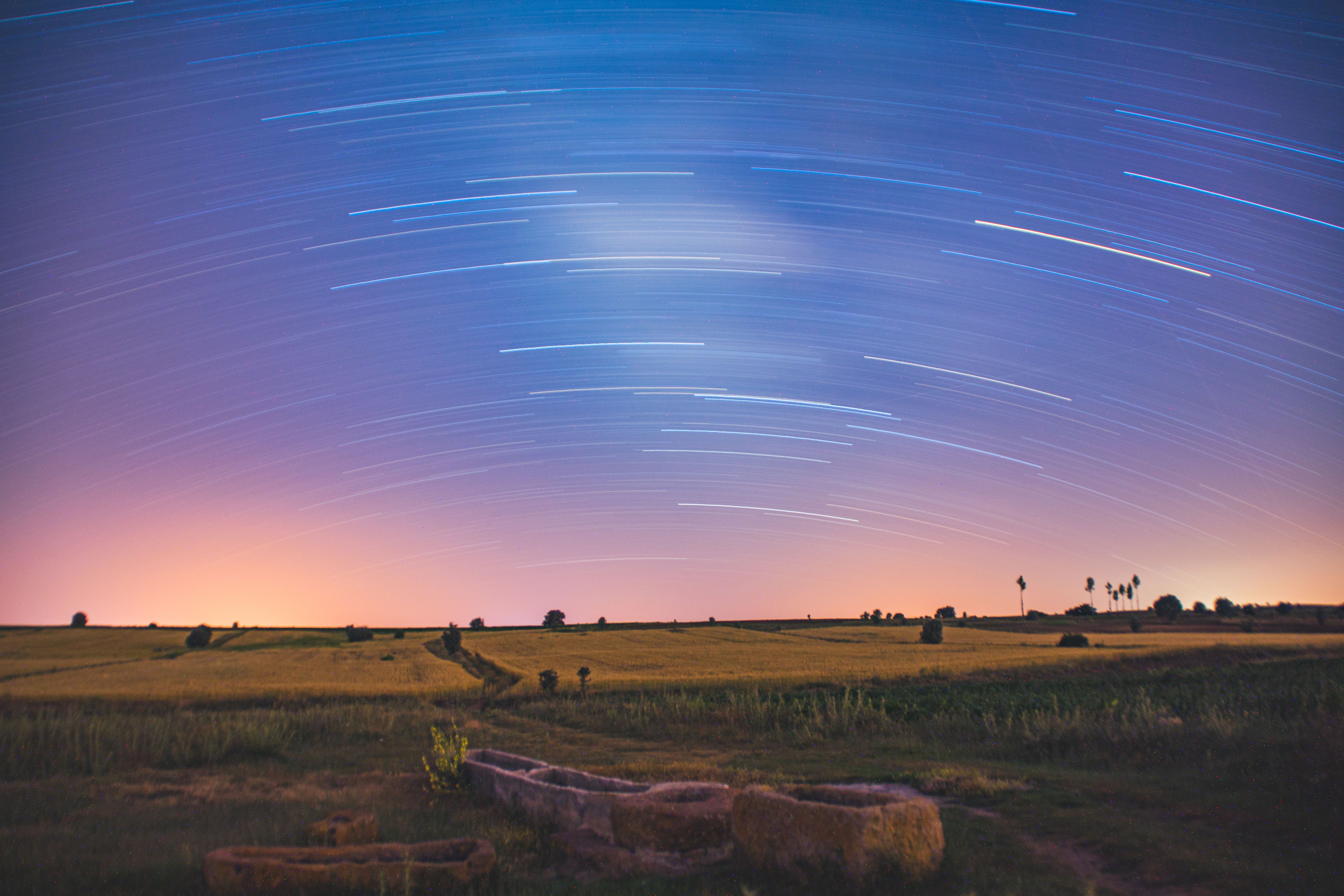 Stunning Star Trails in Night Sky Over Fields · Free Stock Photo