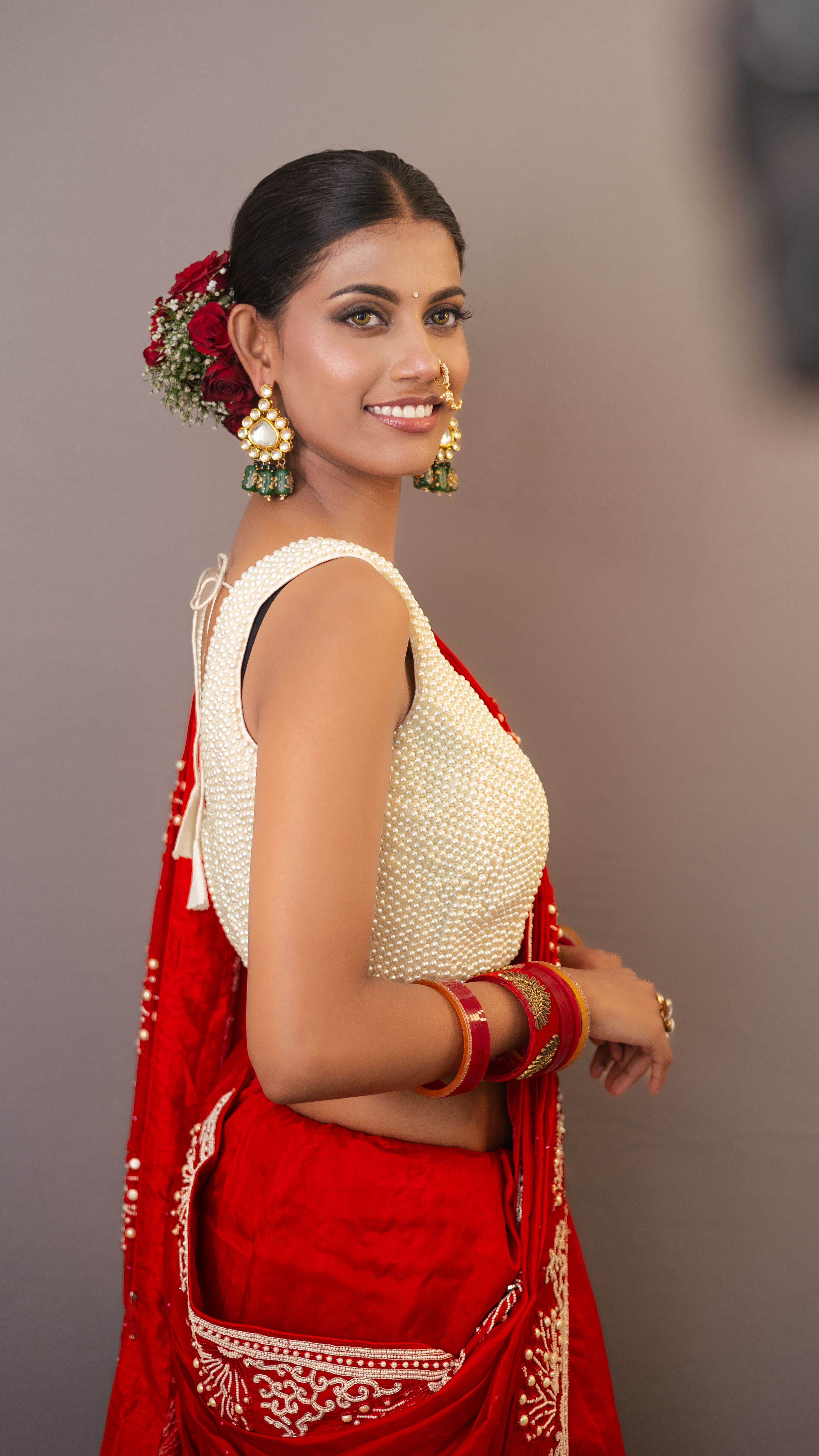 Woman in Traditional Red Saree with Floral Hairpiece · Free Stock Photo