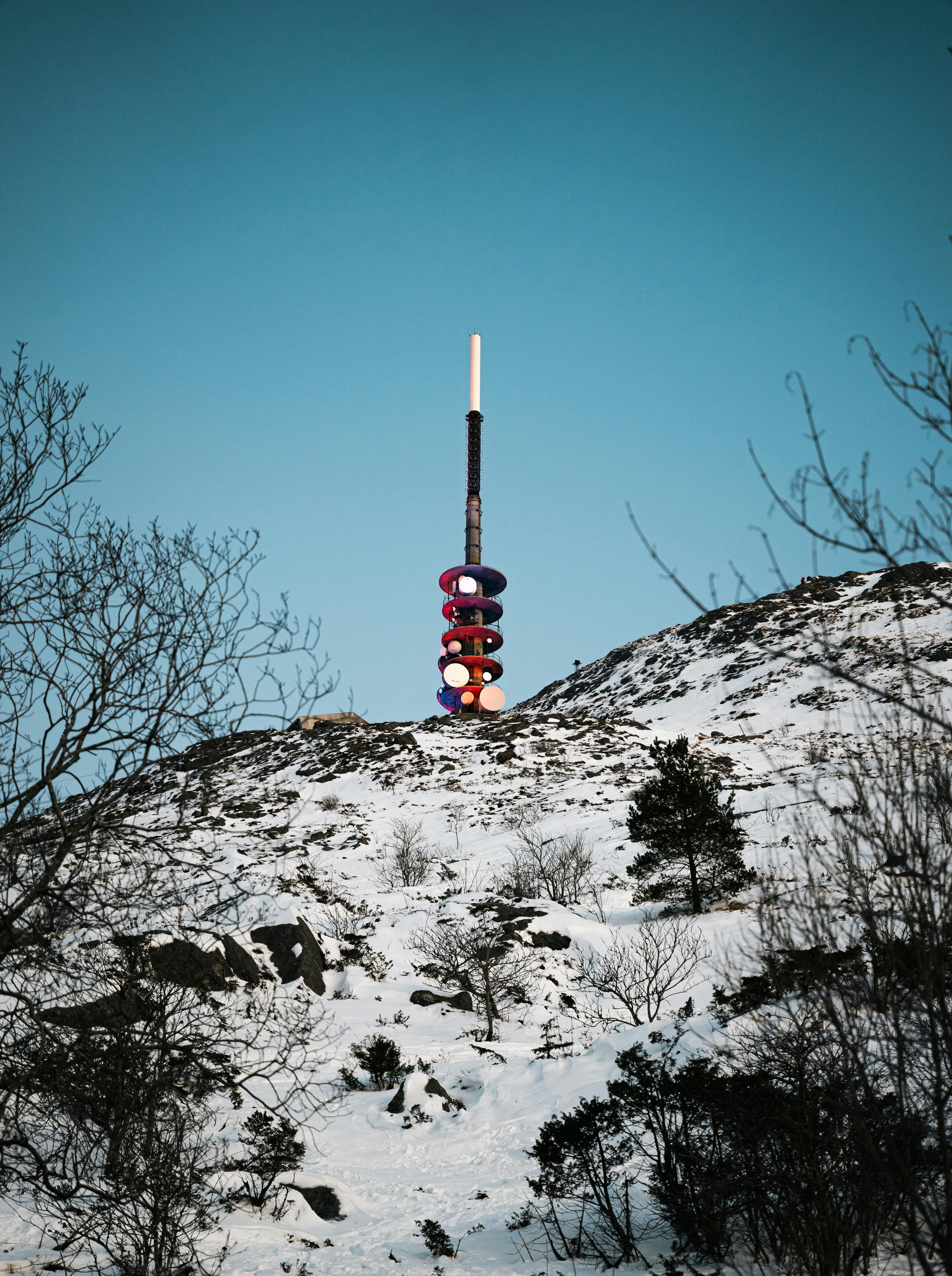 Colorful Tower on Snowy Hill Under Clear Sky · Free Stock Photo