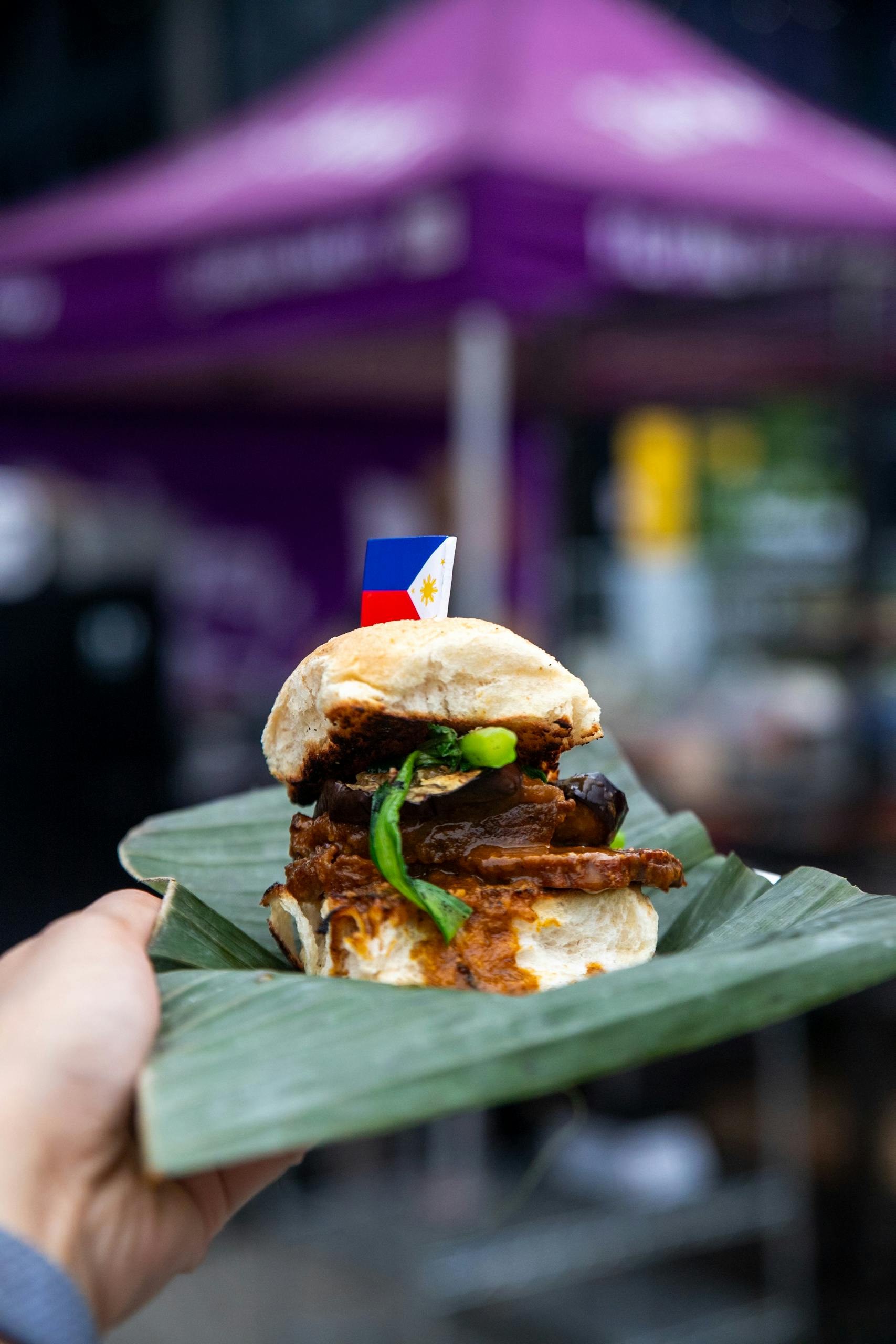 Delicious Filipino Burger at Outdoor Food Stall · Free Stock Photo