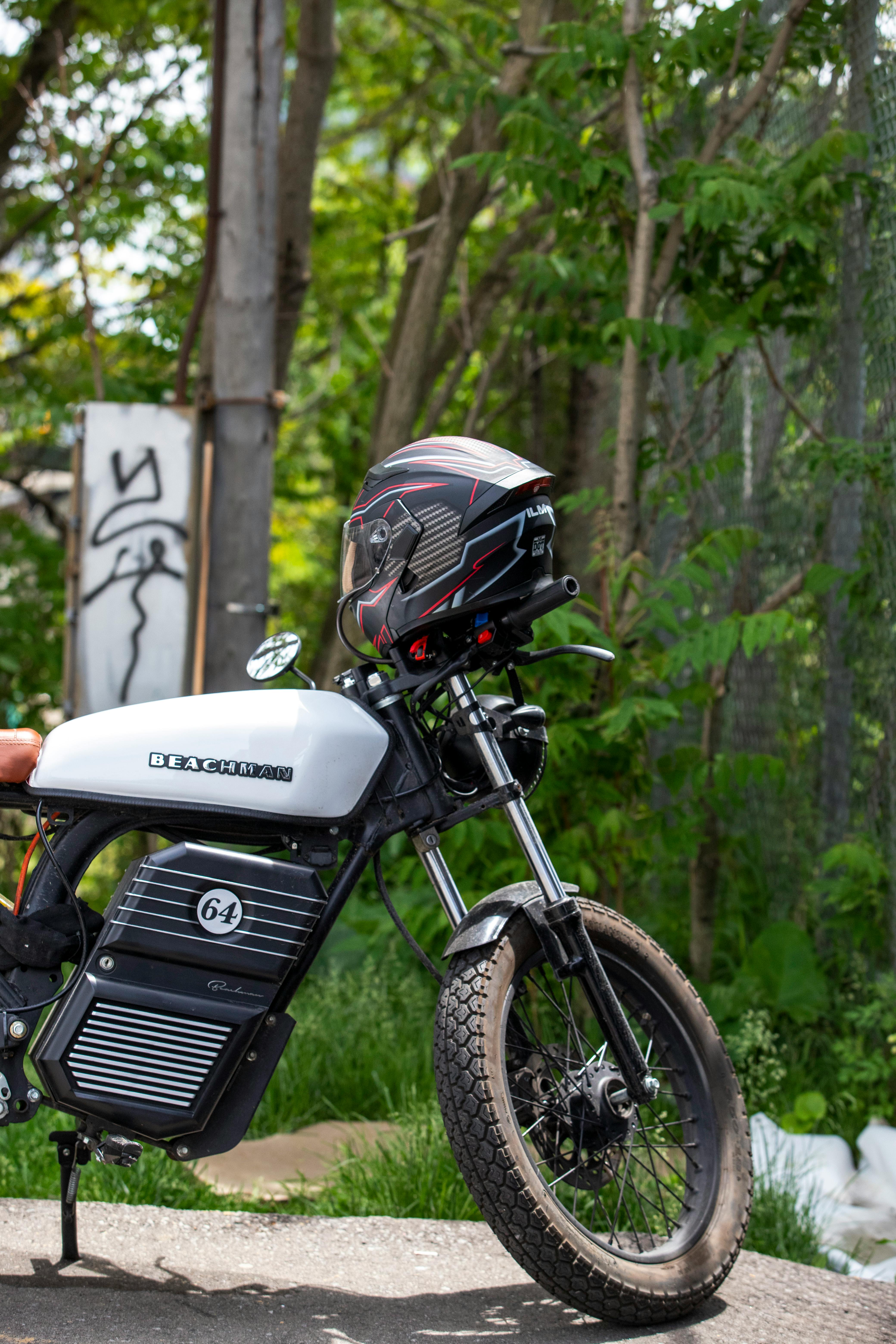 Retro Electric Motorcycle in Green Forest Setting · Free Stock Photo