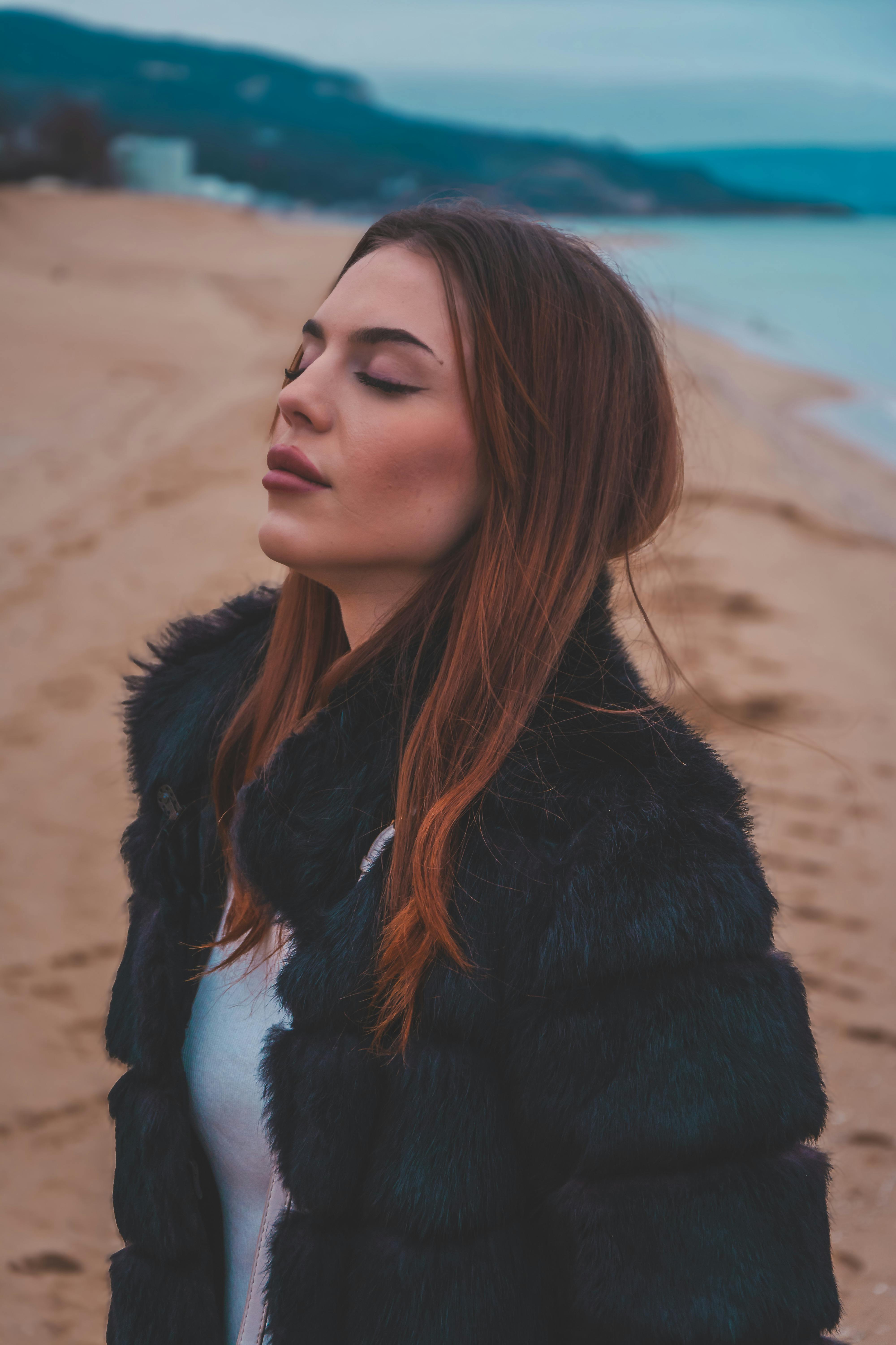 Young Woman Enjoying Solitude on a Beach · Free Stock Photo