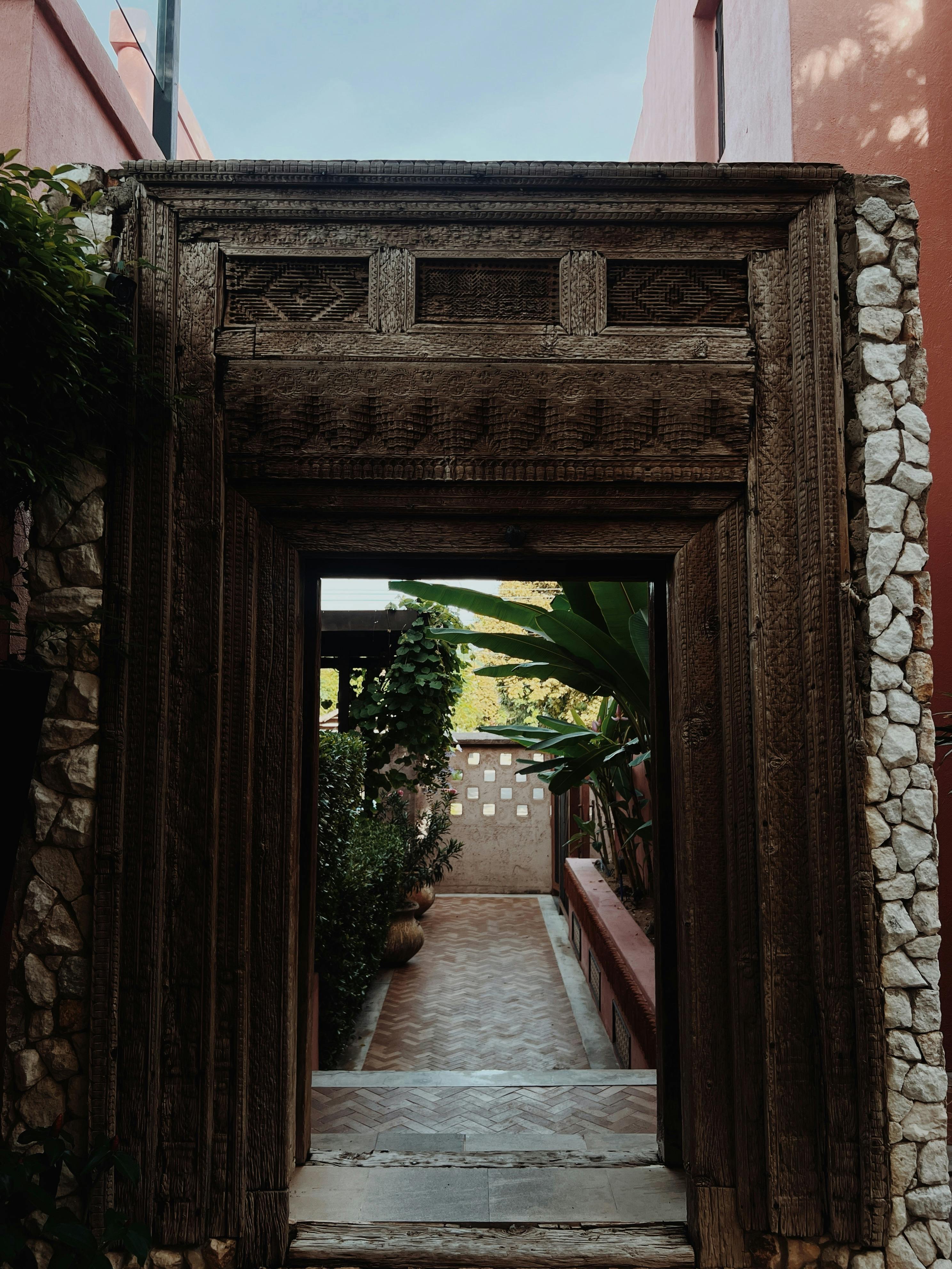 Rustic Wooden Archway Leading to Lush Garden · Free Stock Photo
