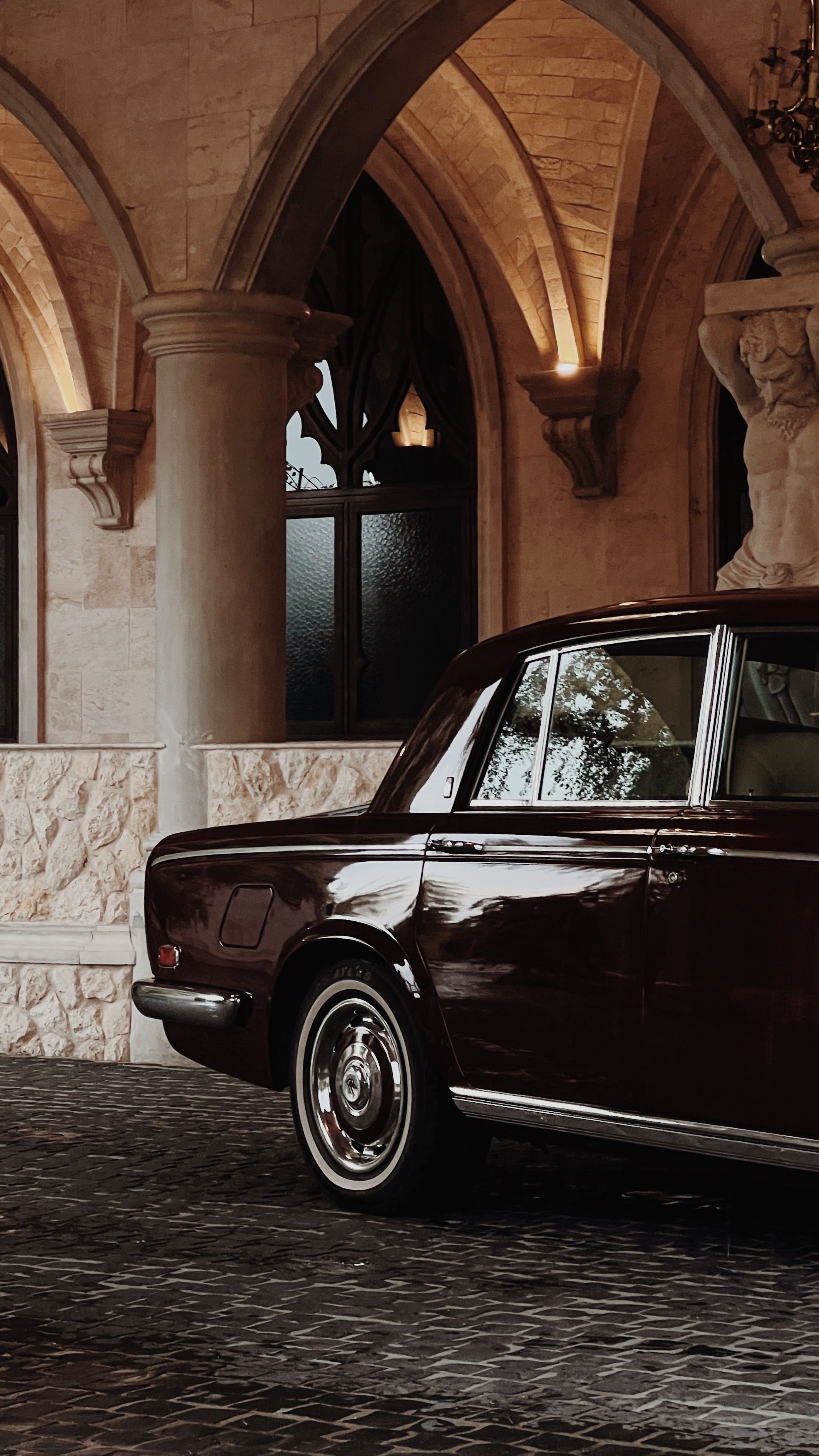 Classic Luxury Car in Elegant Stone Archway Setting · Free Stock Photo