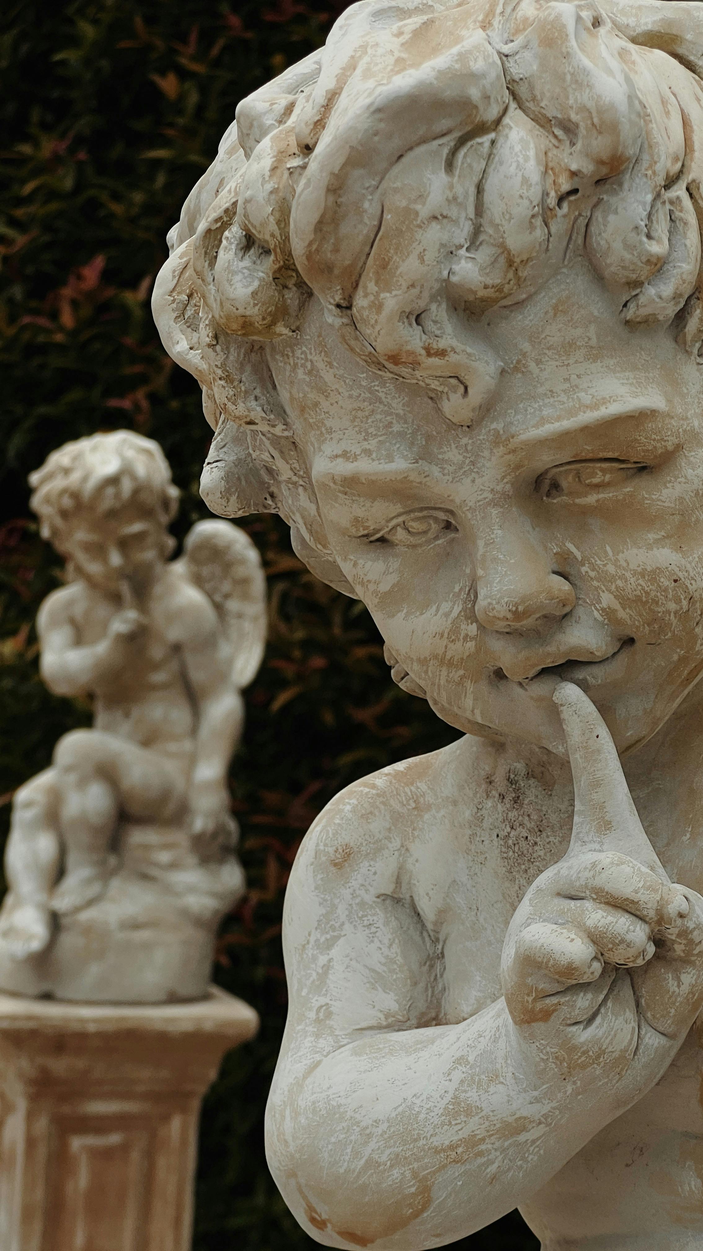 Close-up of Cherub Statues in Garden Setting · Free Stock Photo