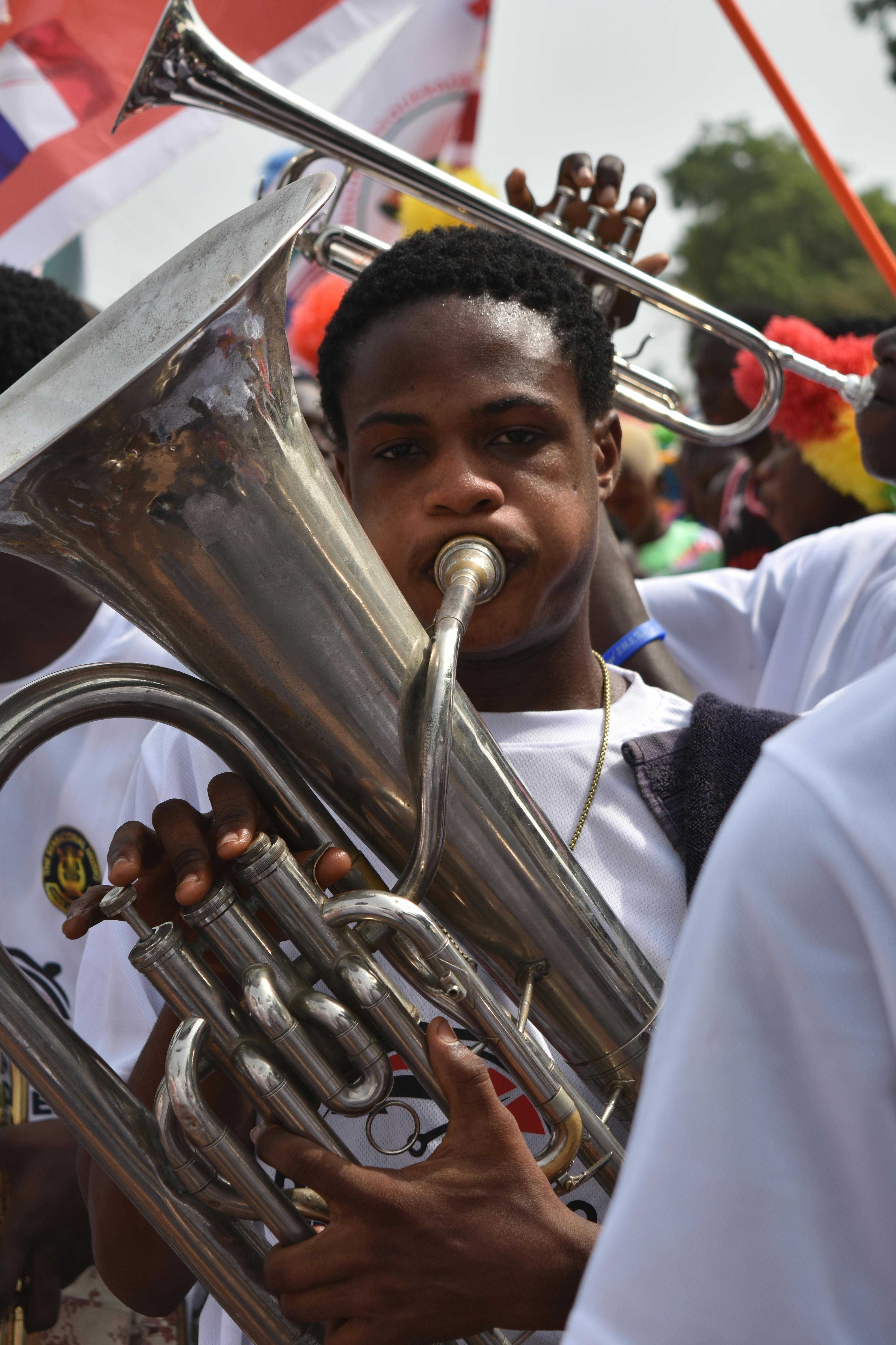 Young Musician Playing Tuba in Festive Parade · Free Stock Photo